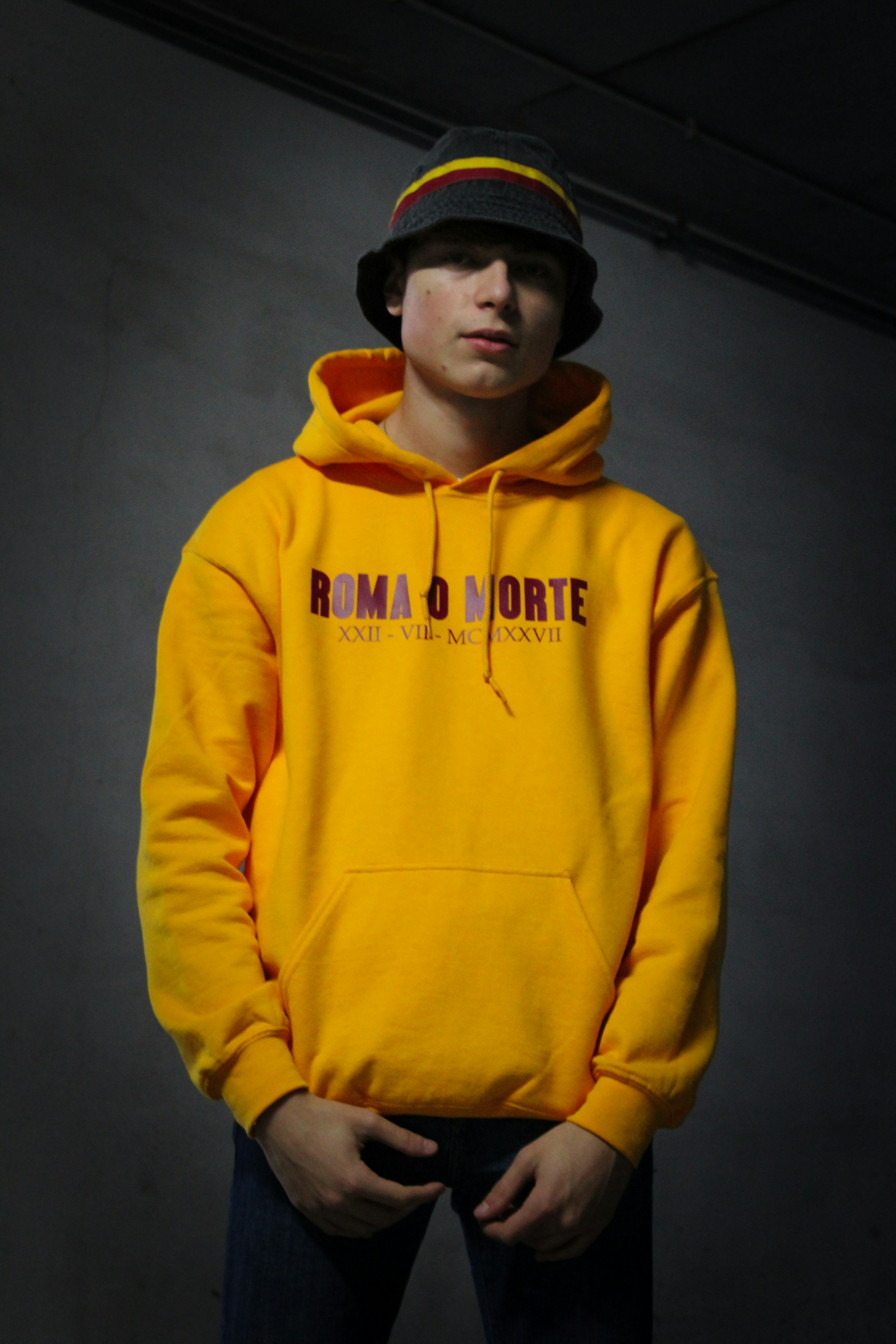 Gold Hoodie in a Dim Gallery: Portrait of a Quiet Confidence