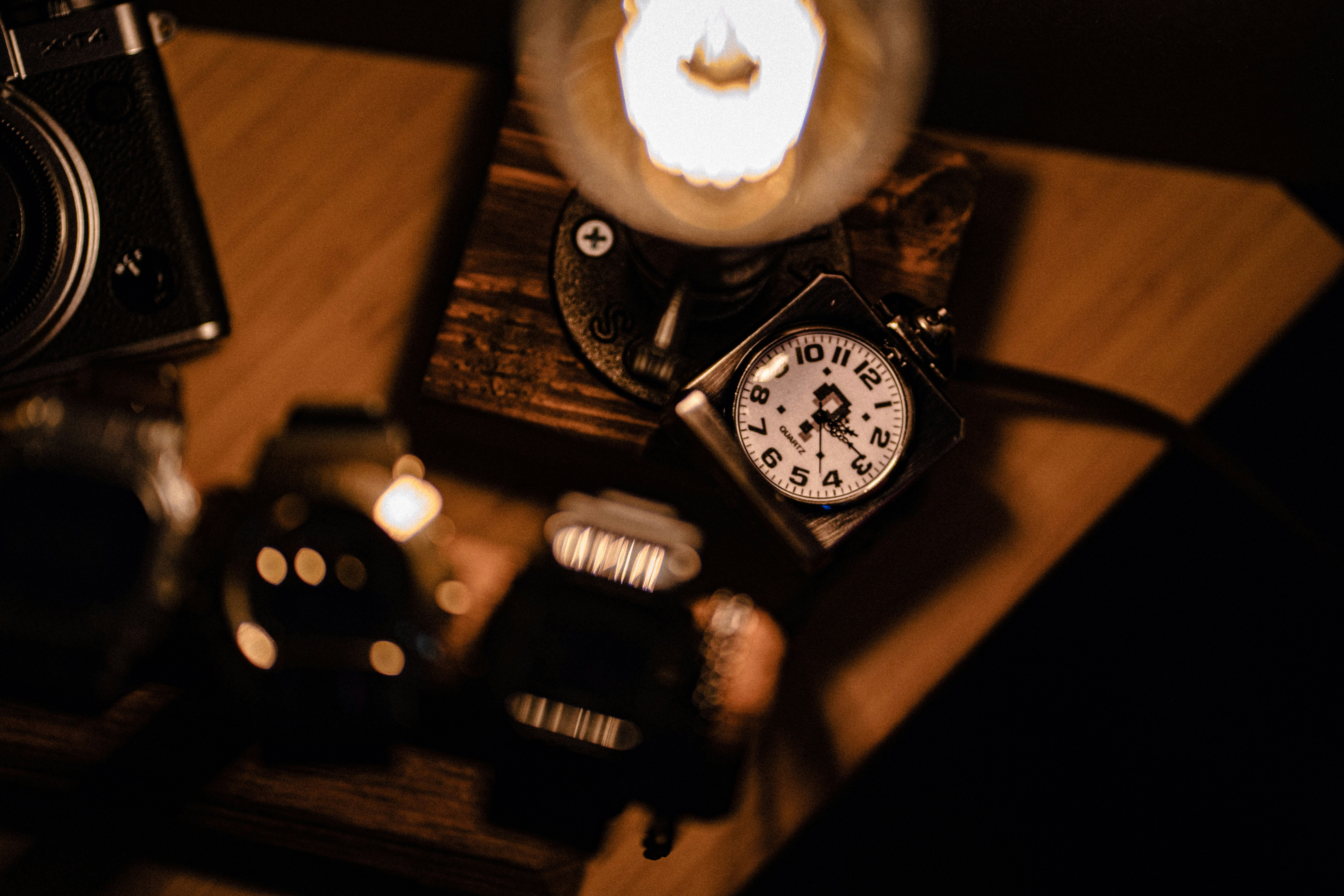 Amber-lit Desk Clock Amid Retro Camera Gear