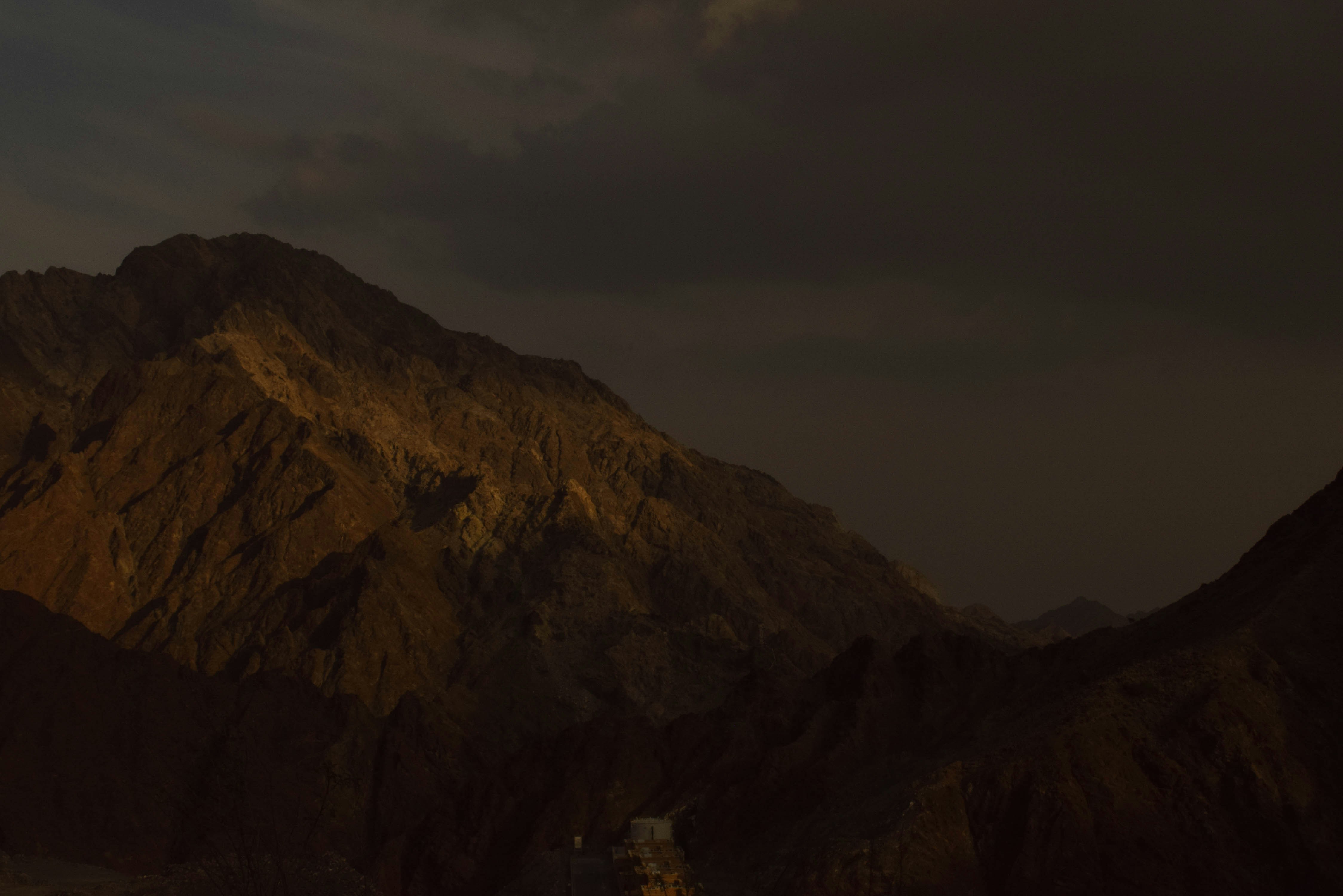 light of the fallen.
theres this really cool neighbourhood at the bottom, I bet they're nice people | brown and gray mountain under gray clouds