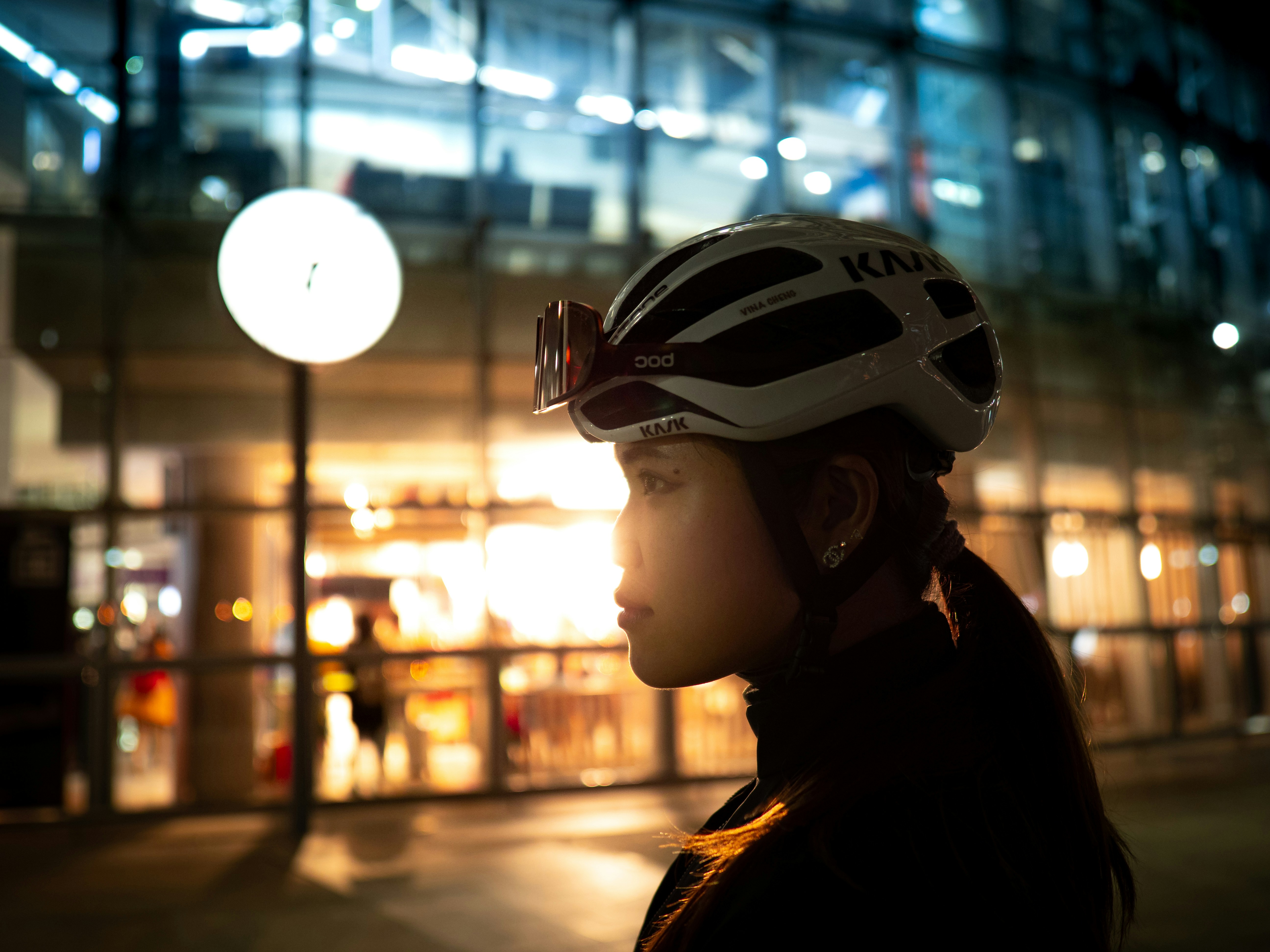 Night rider: profile of focus against illuminated storefronts
