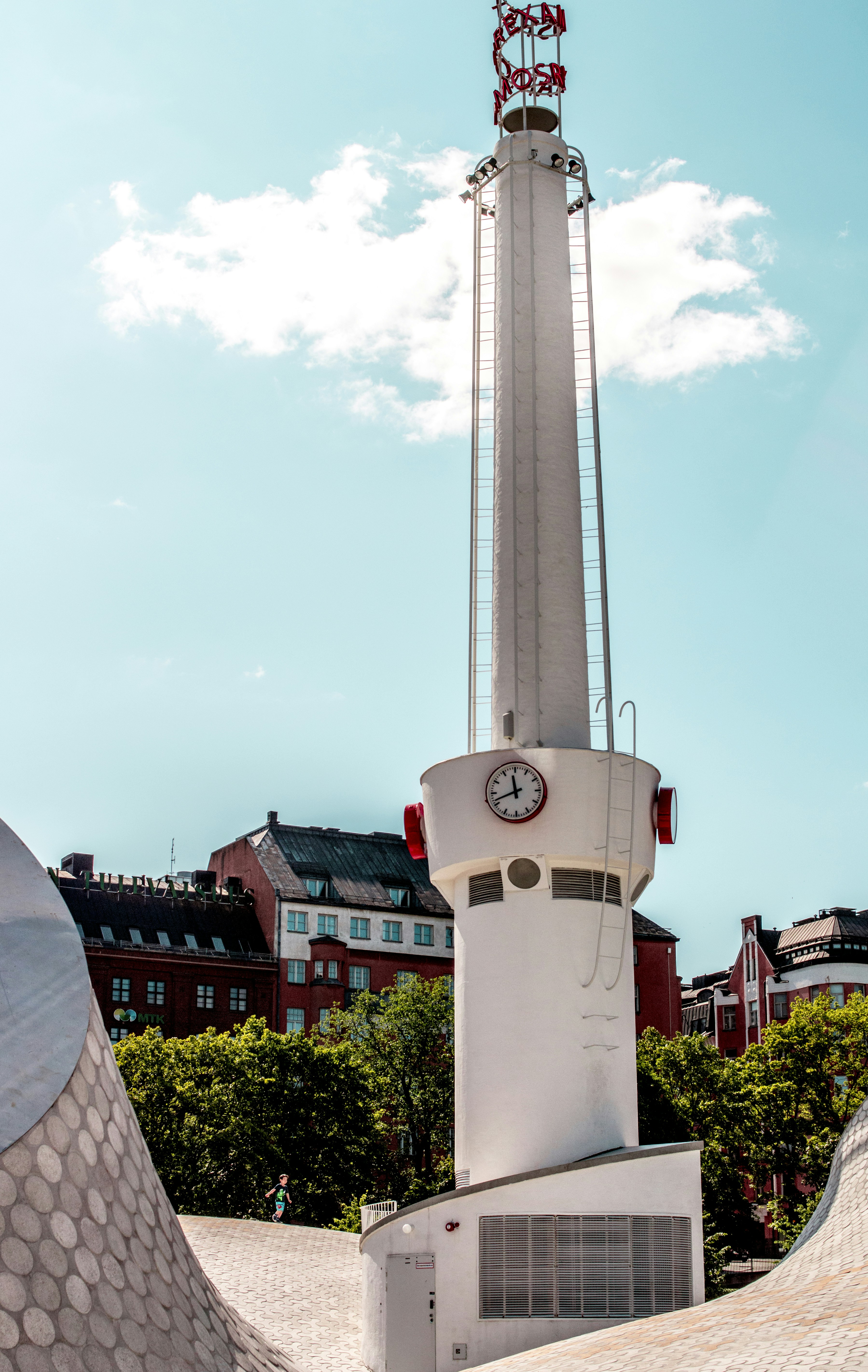 Clocktower Rising Over Curved Concrete Ramps