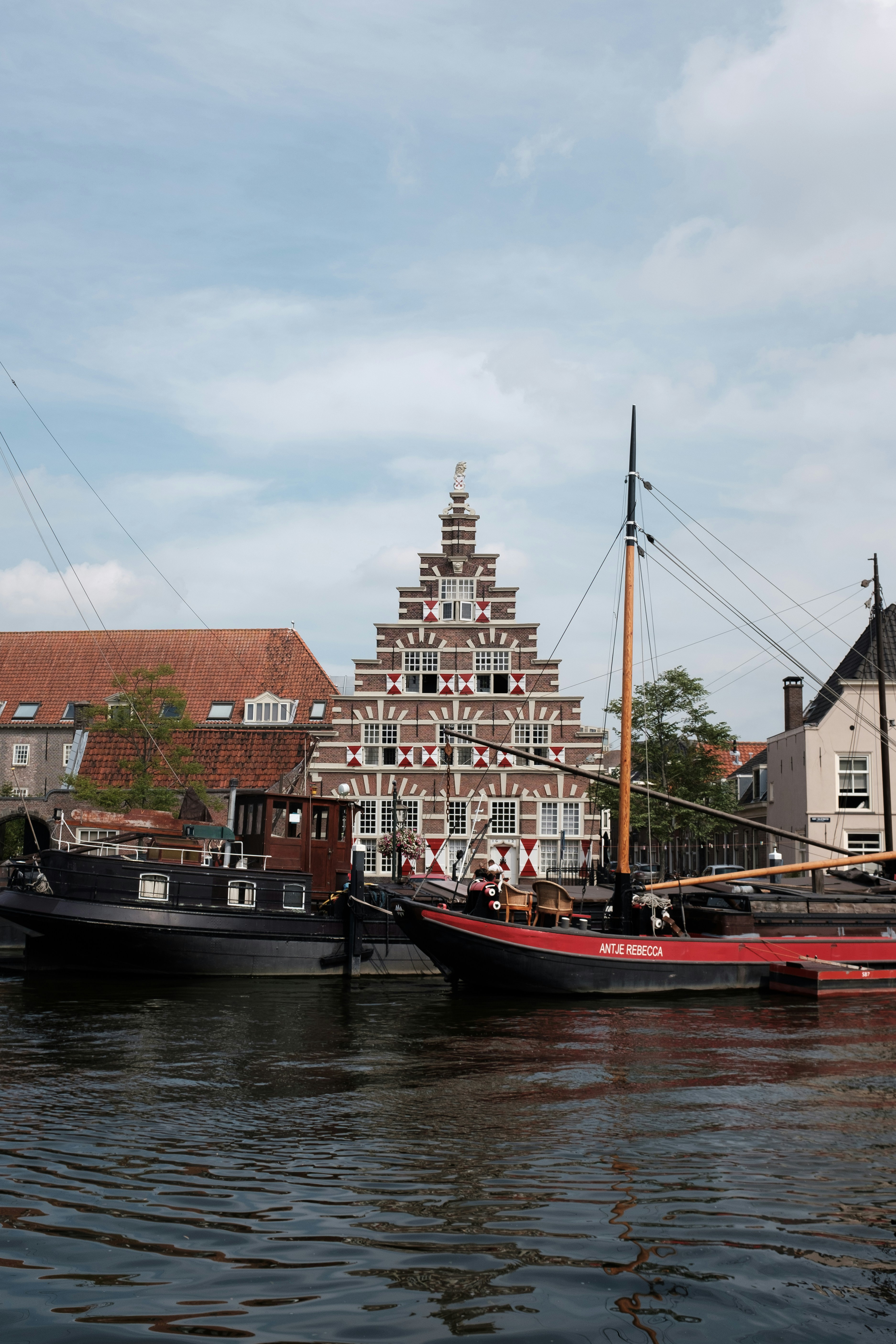 Step-Gable Harbor: A Brick Landmark Framed by Boats