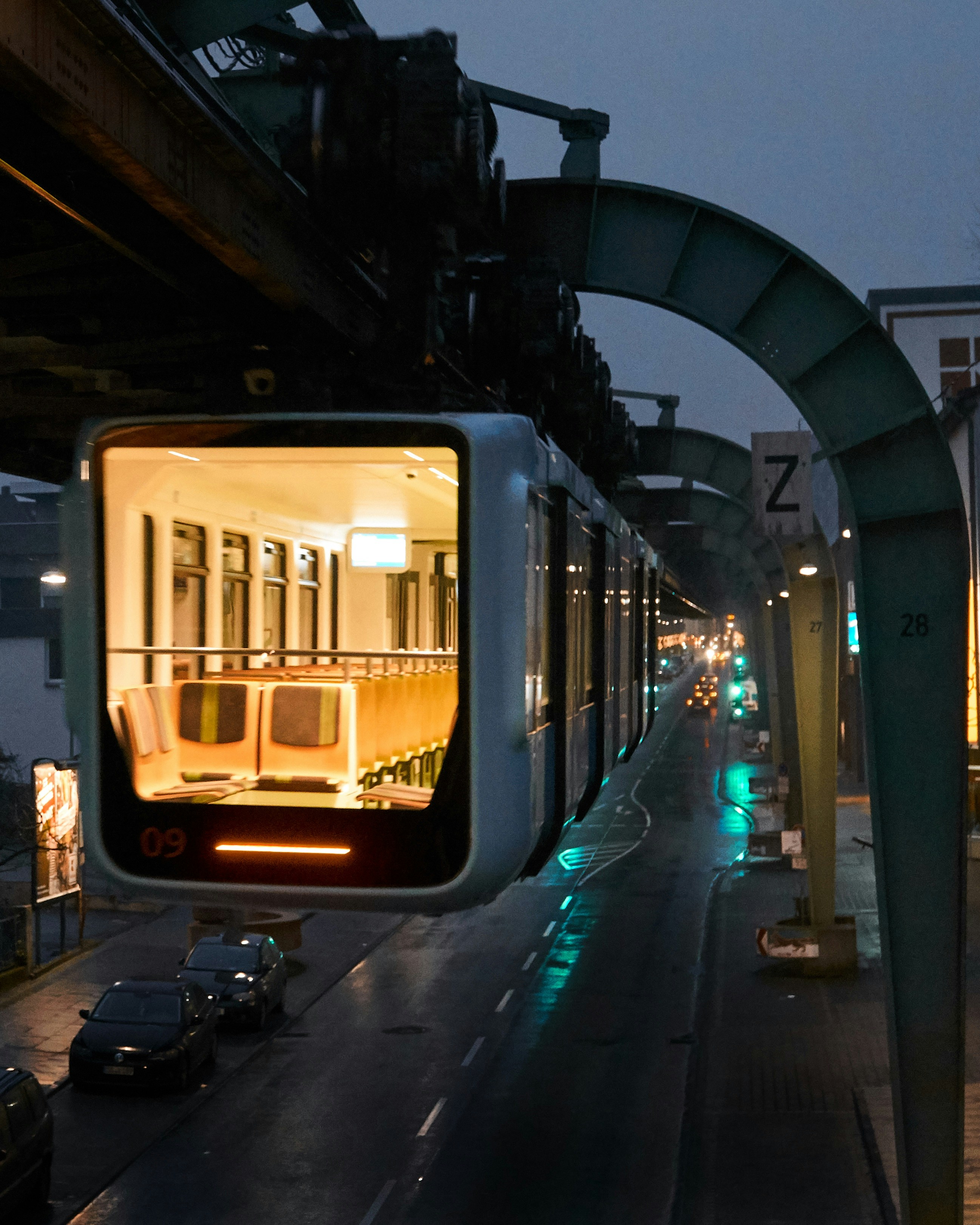 Glowing Cabin Afloat Over Rain-Washed Avenues: Night Ride on an Elevated Tram
