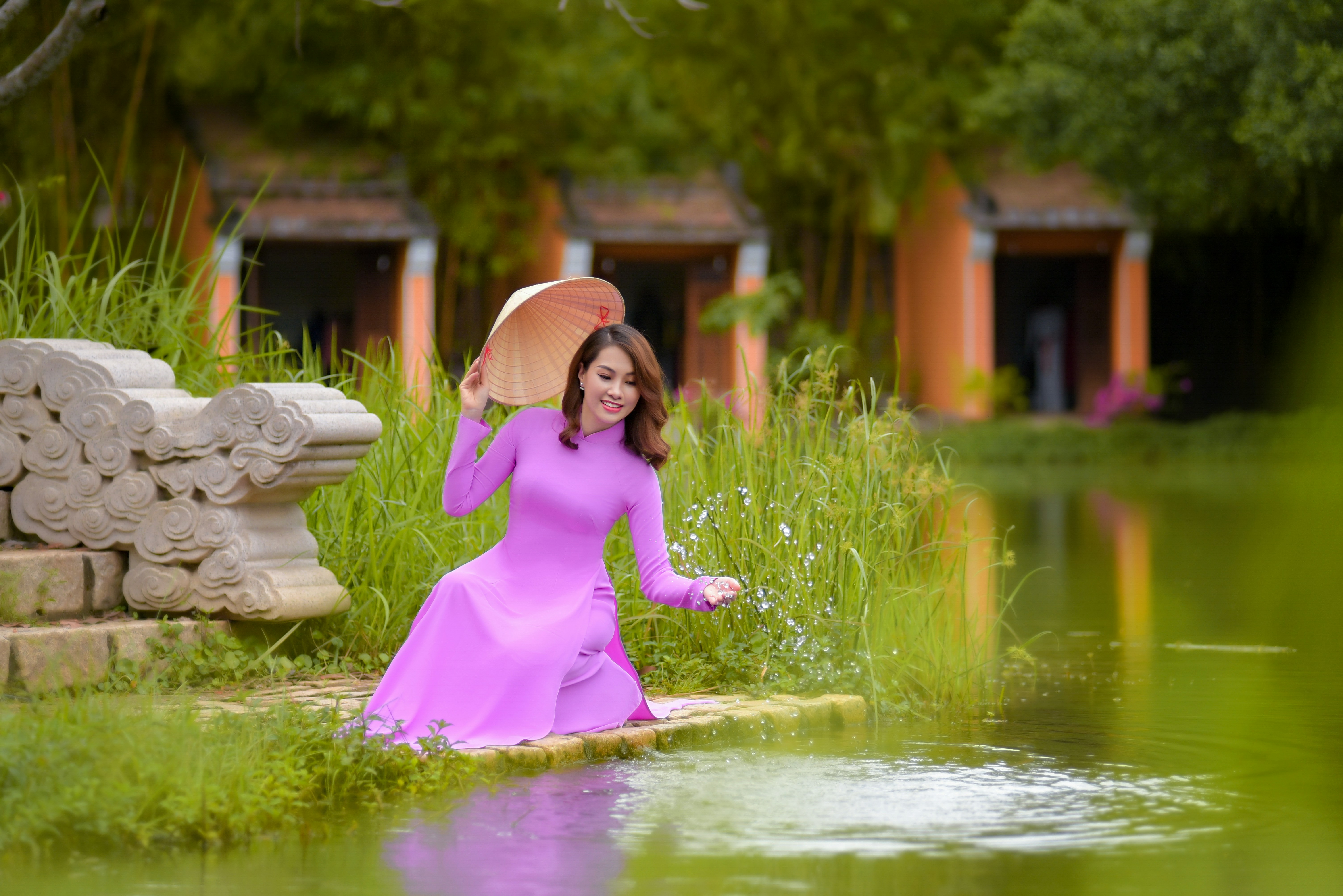 girl in pink dress standing on water during daytime