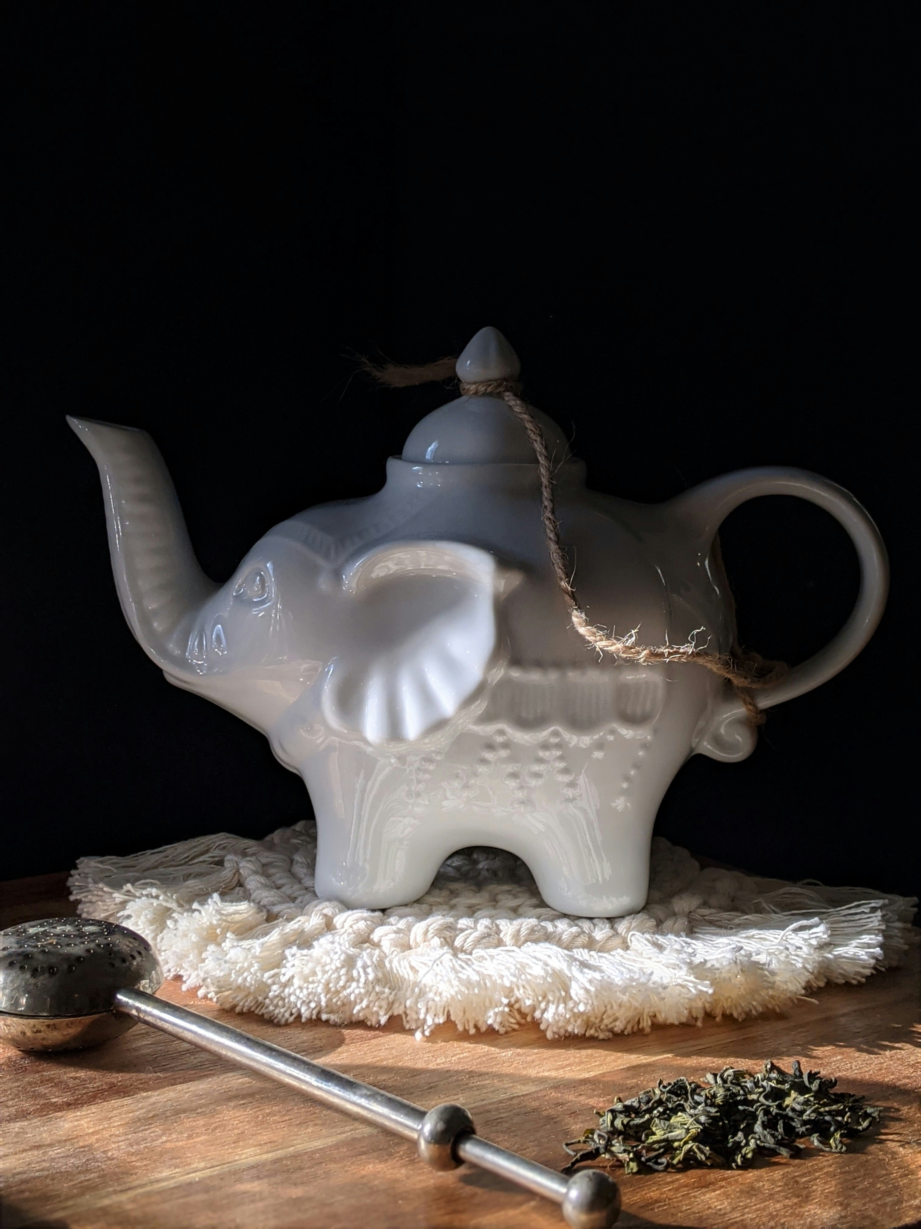 Whimsical Mint-Eyed Teapot Keeper on a Crochet Linen Stage