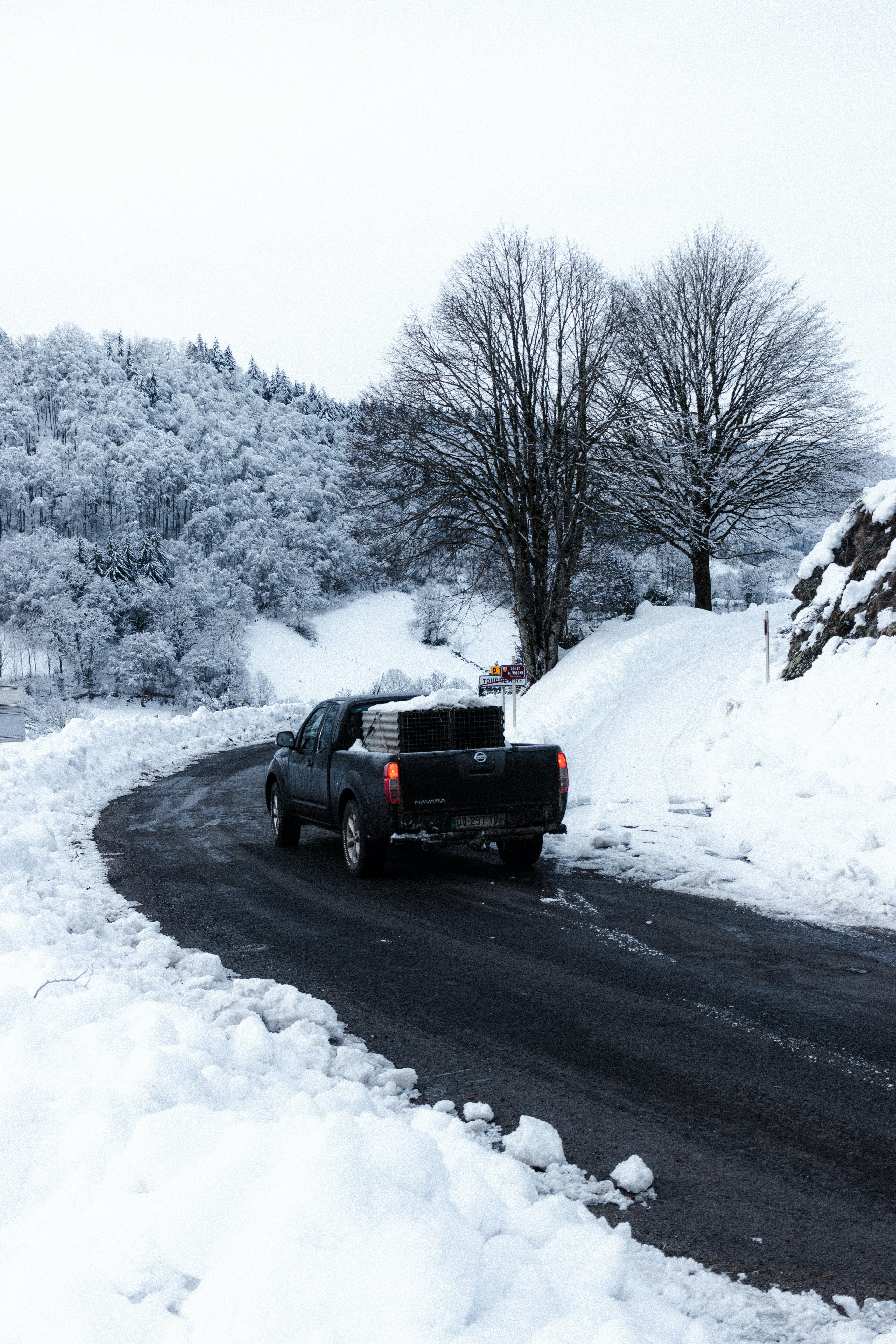 black suv on snow covered road during daytime