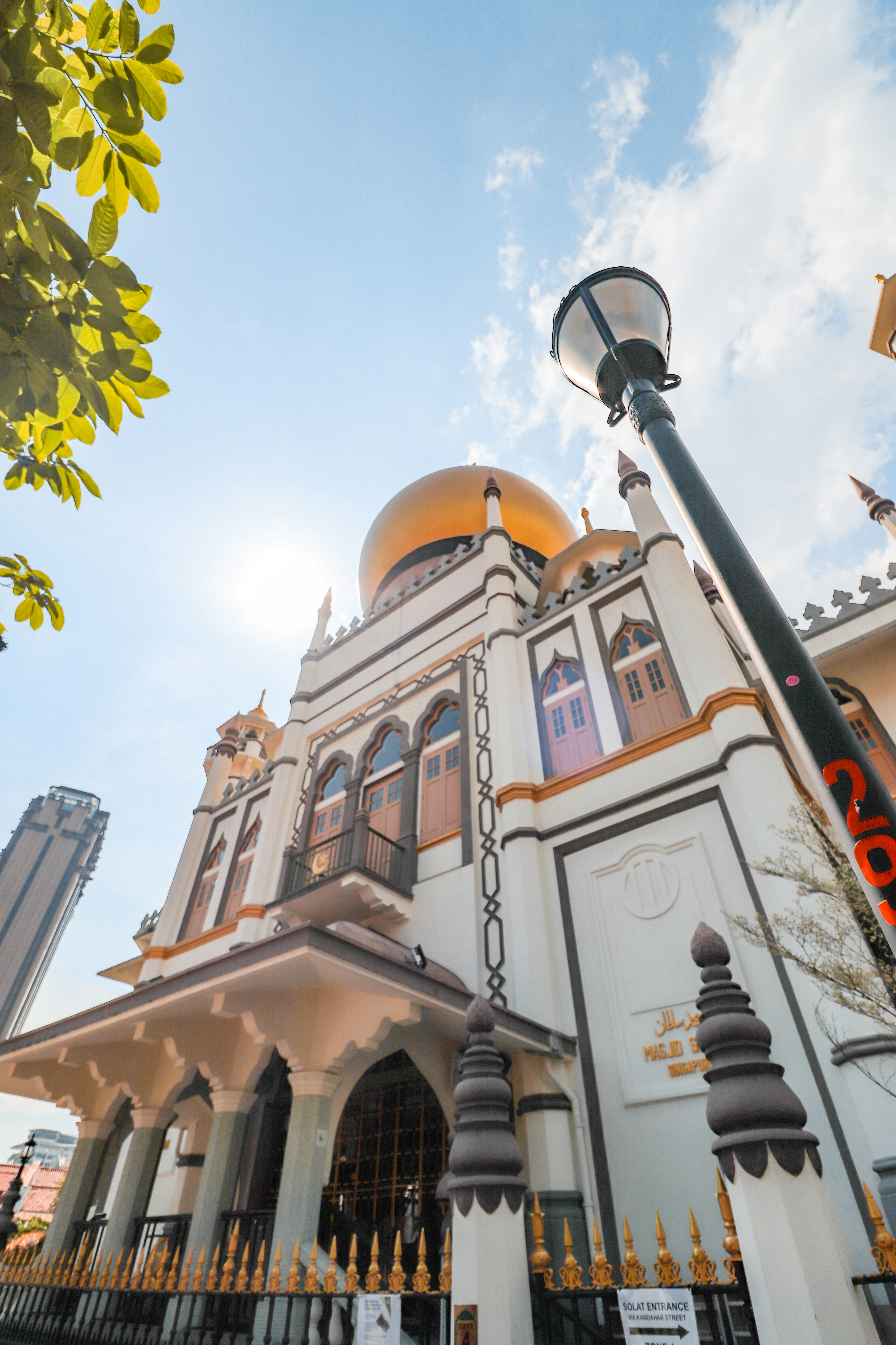 Gold Dome Rising: Morning Light Over a White Mosque-Style Facade