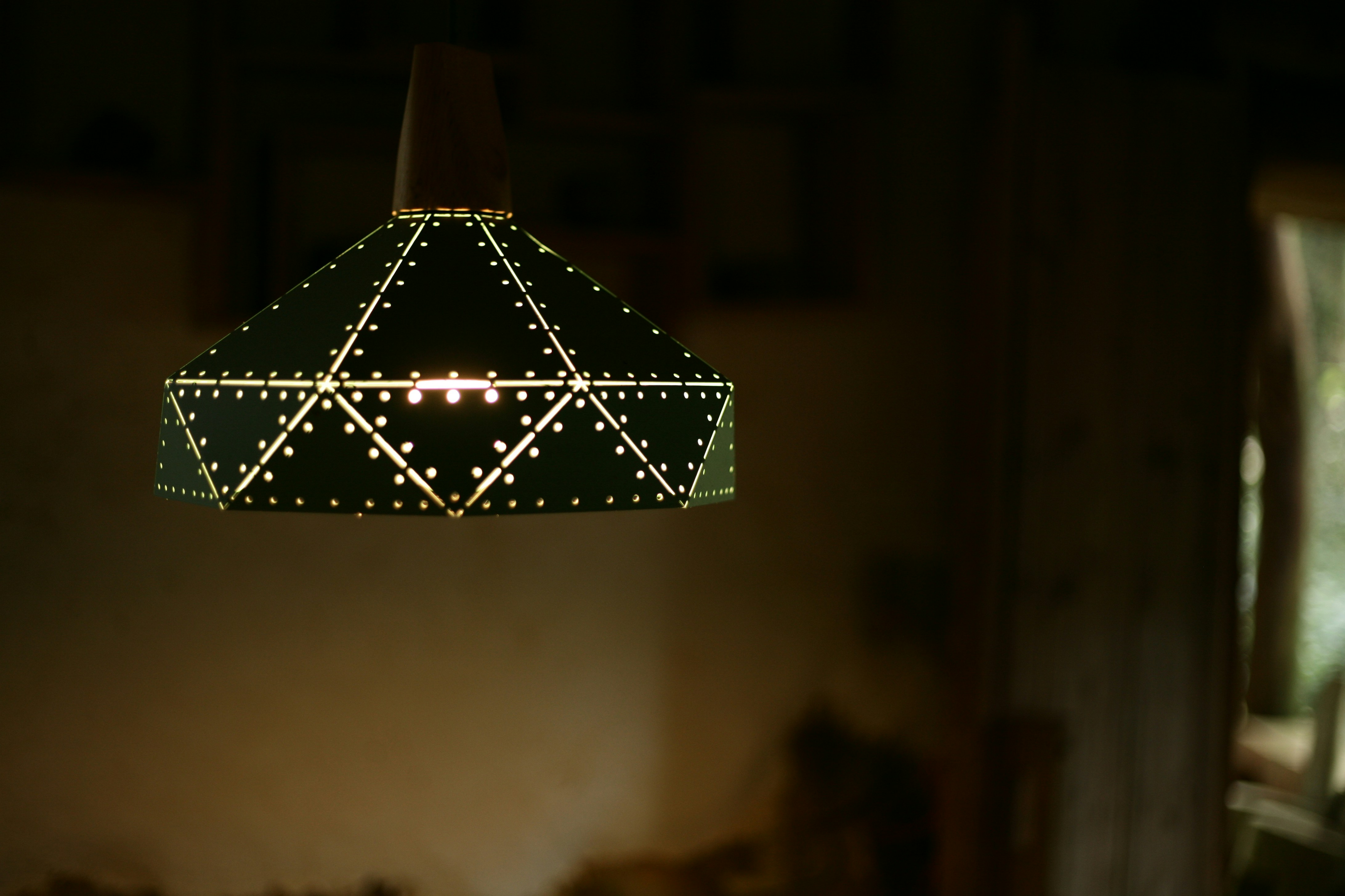 Diamond-Grid Pendant Glow in a Dim Interior