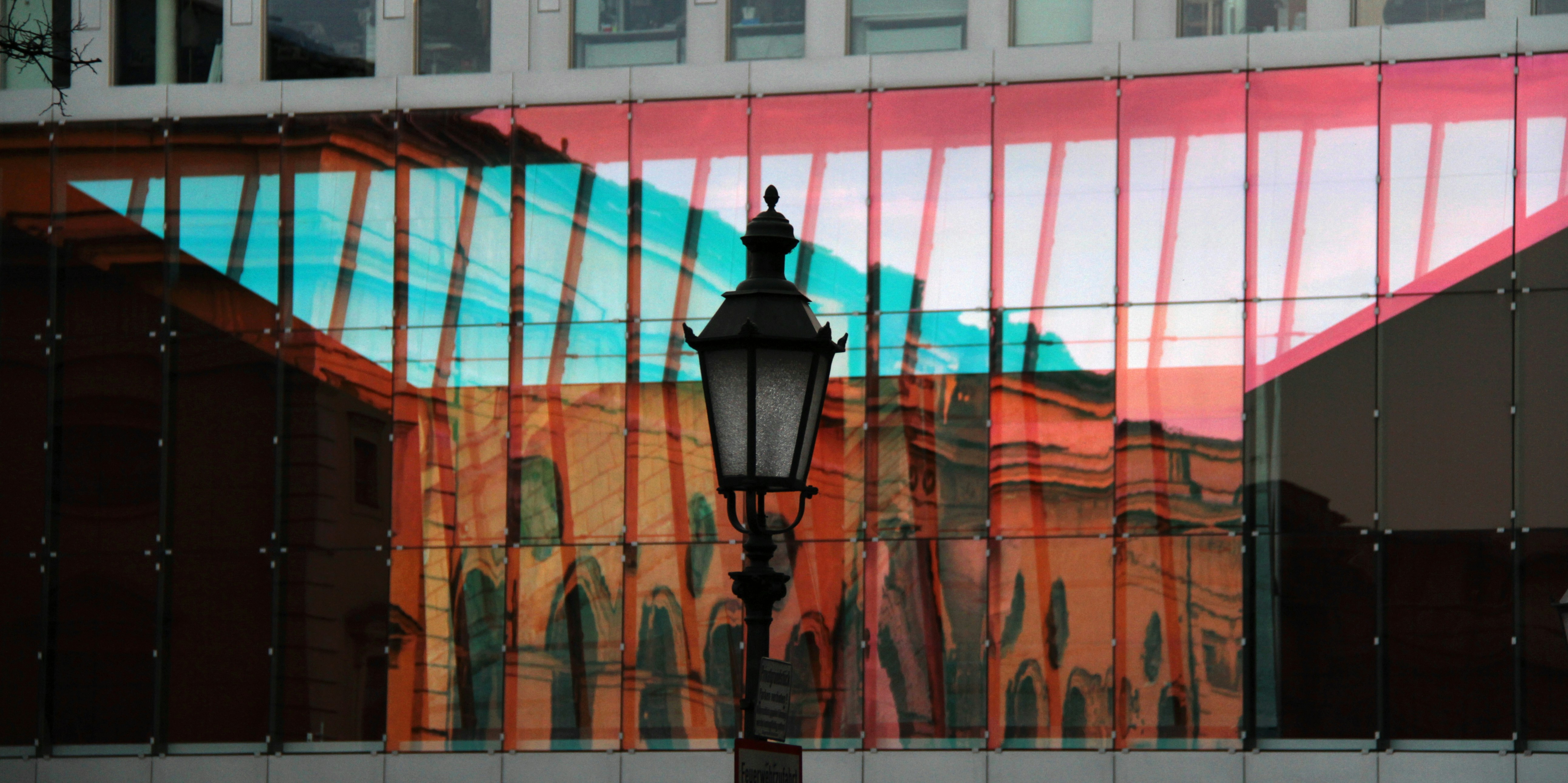 Reflections of a Lantern in a Glass-Front Street