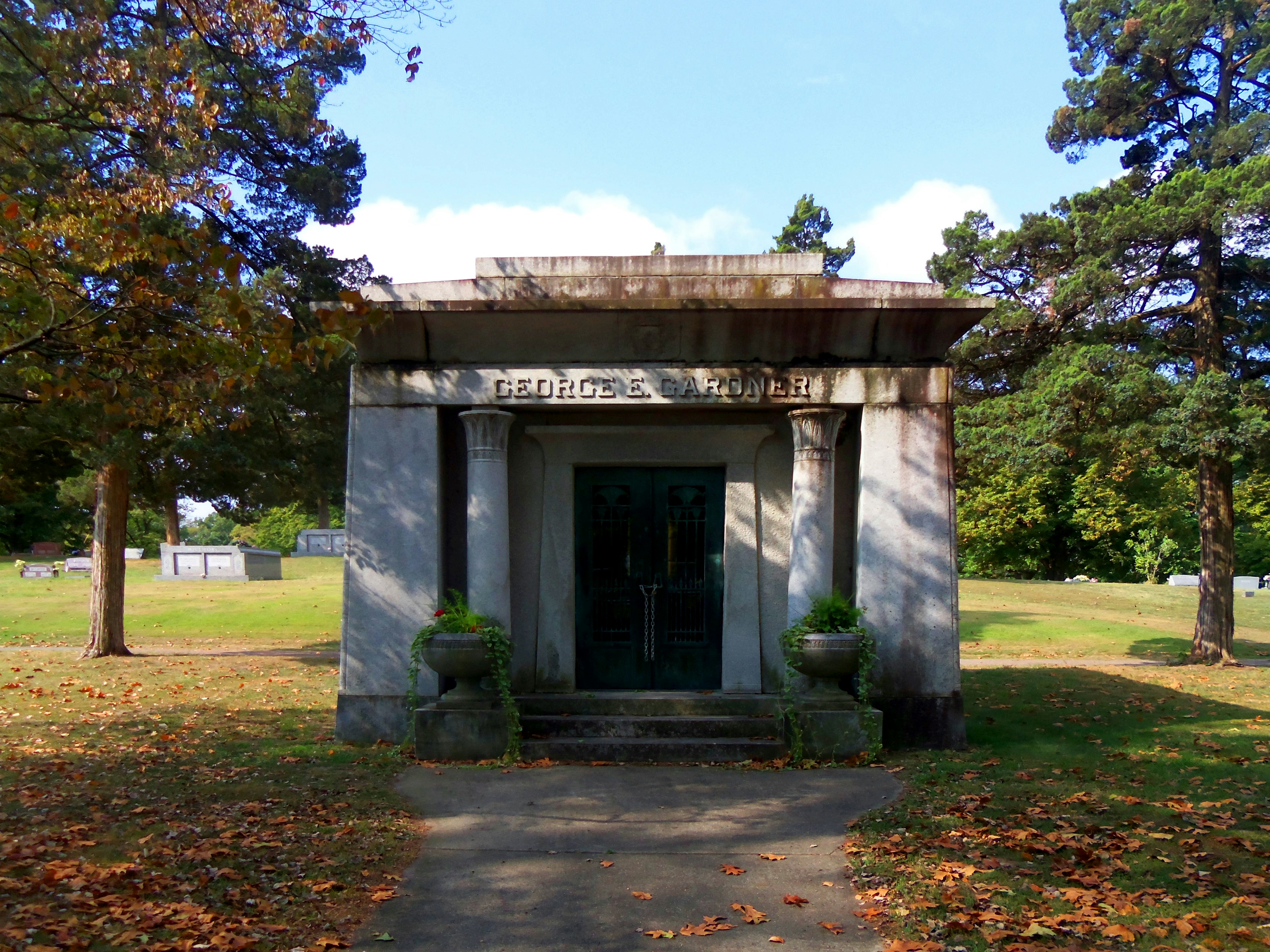 gray concrete building near green trees during daytime
