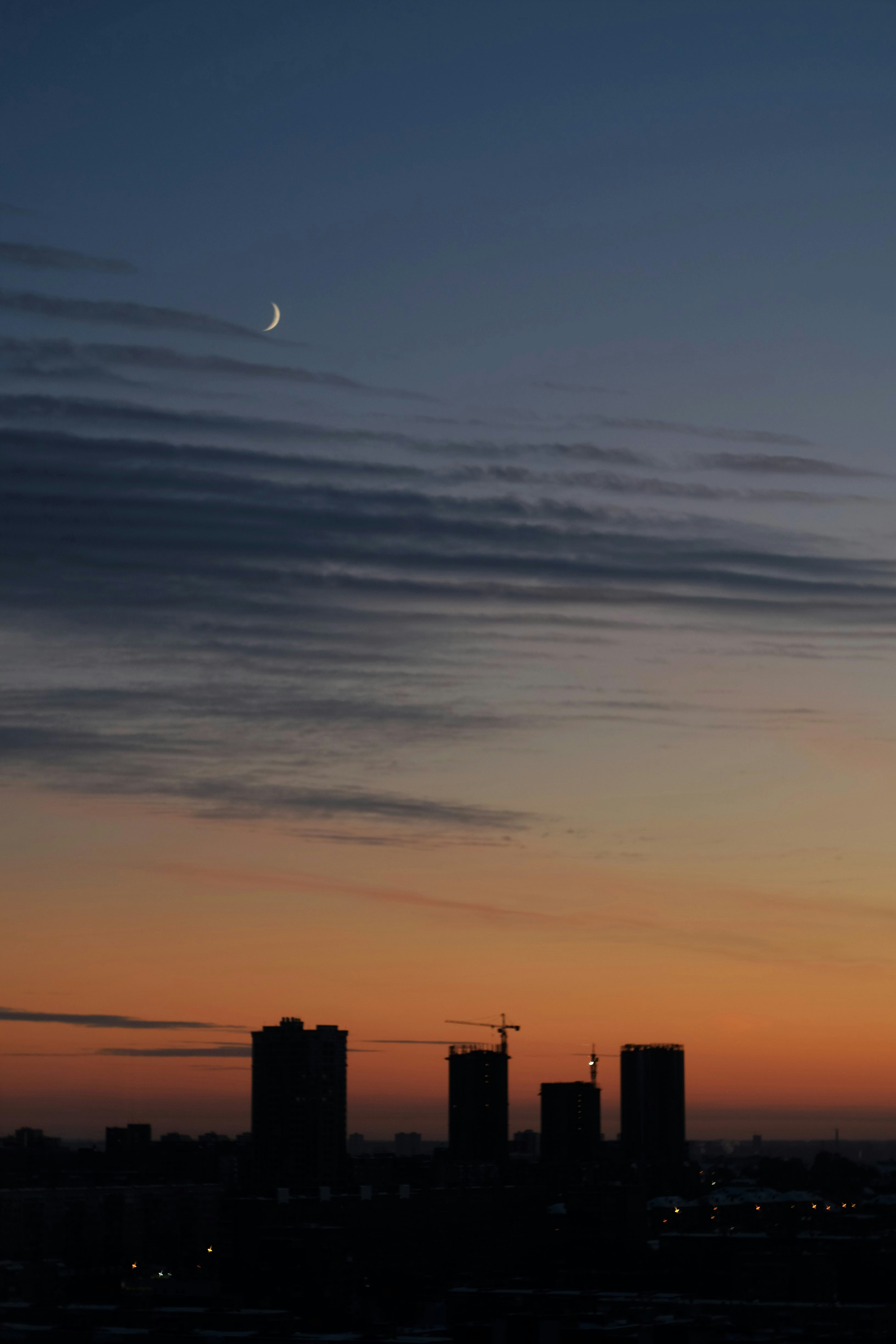 Crescent Moon Over a Quiet Twilight Skyline