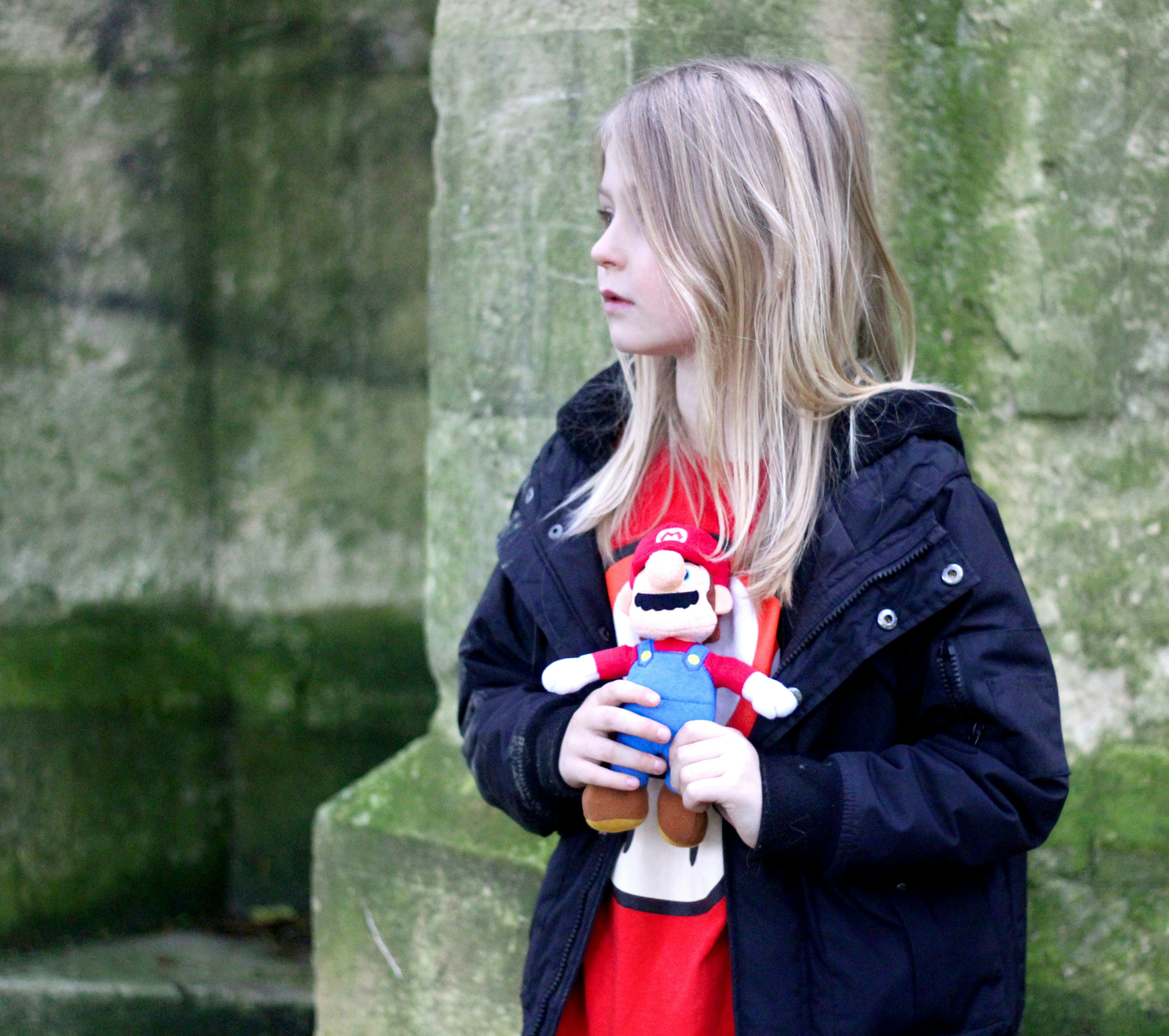 Gazing Past the Pillars: A Girl with a Mario Plush