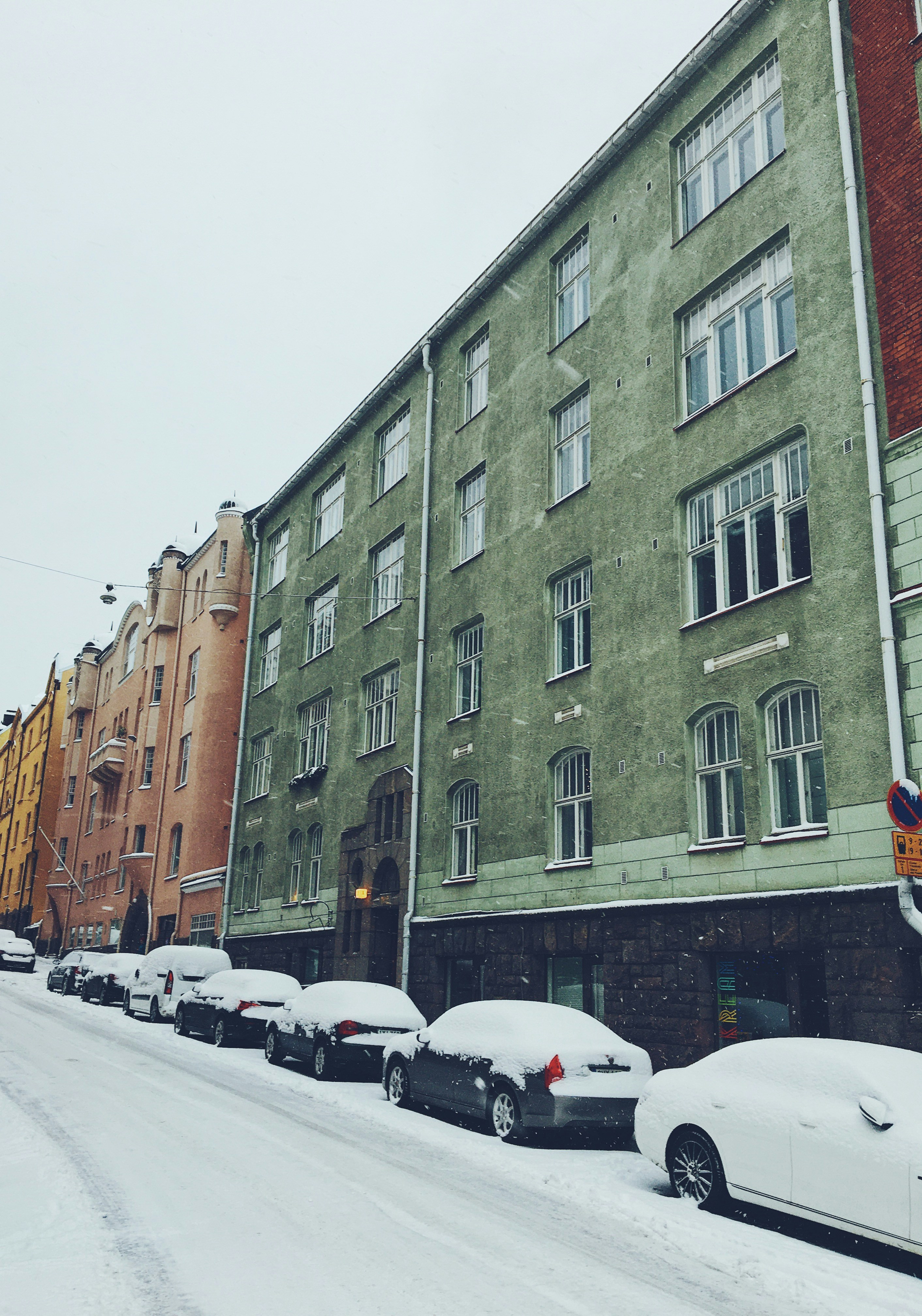 Snow-Blanketed Avenue among Colorful European Facades