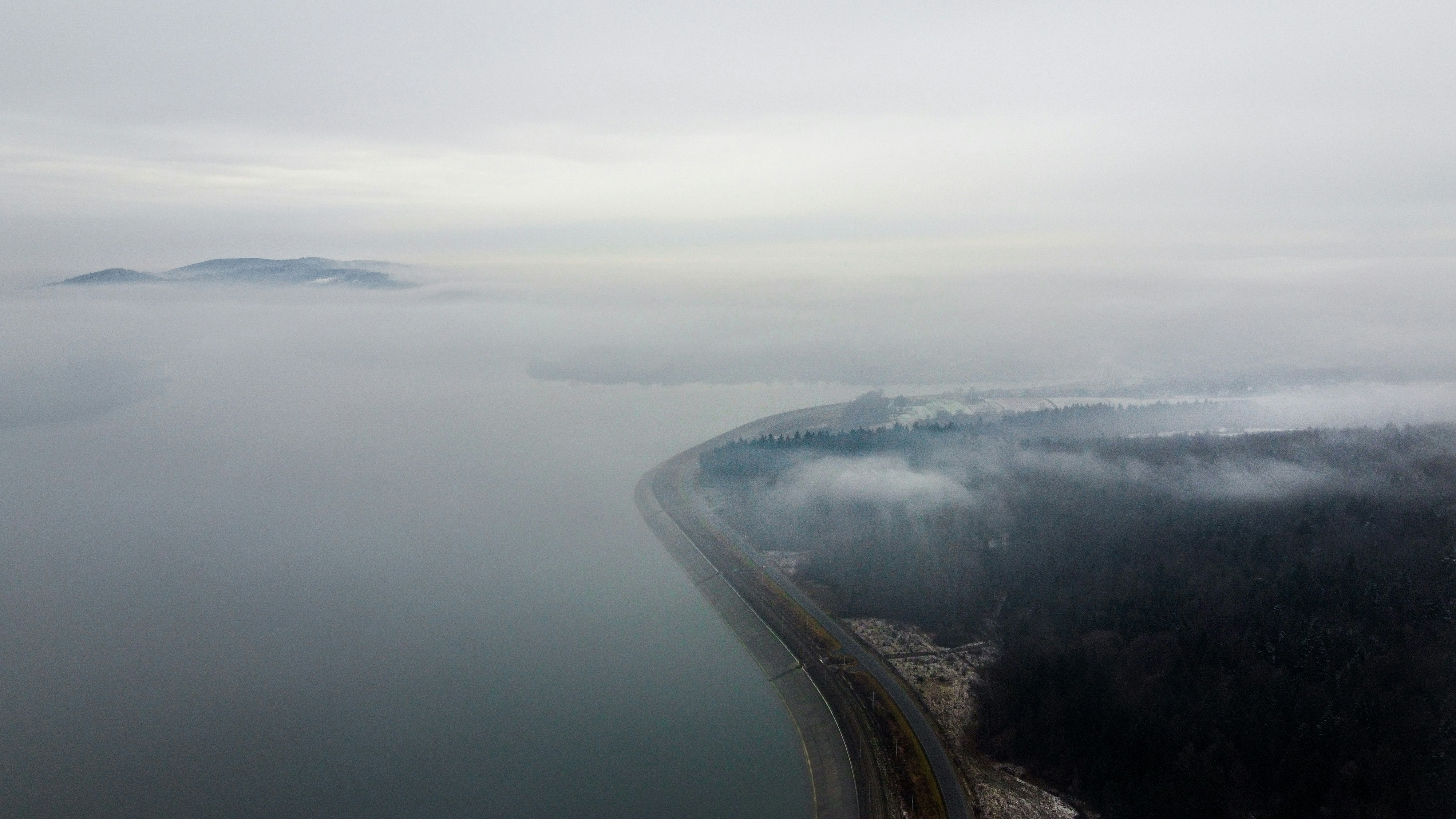 Mist-Rimmed Coastline: A Drone's Quiet Bend
