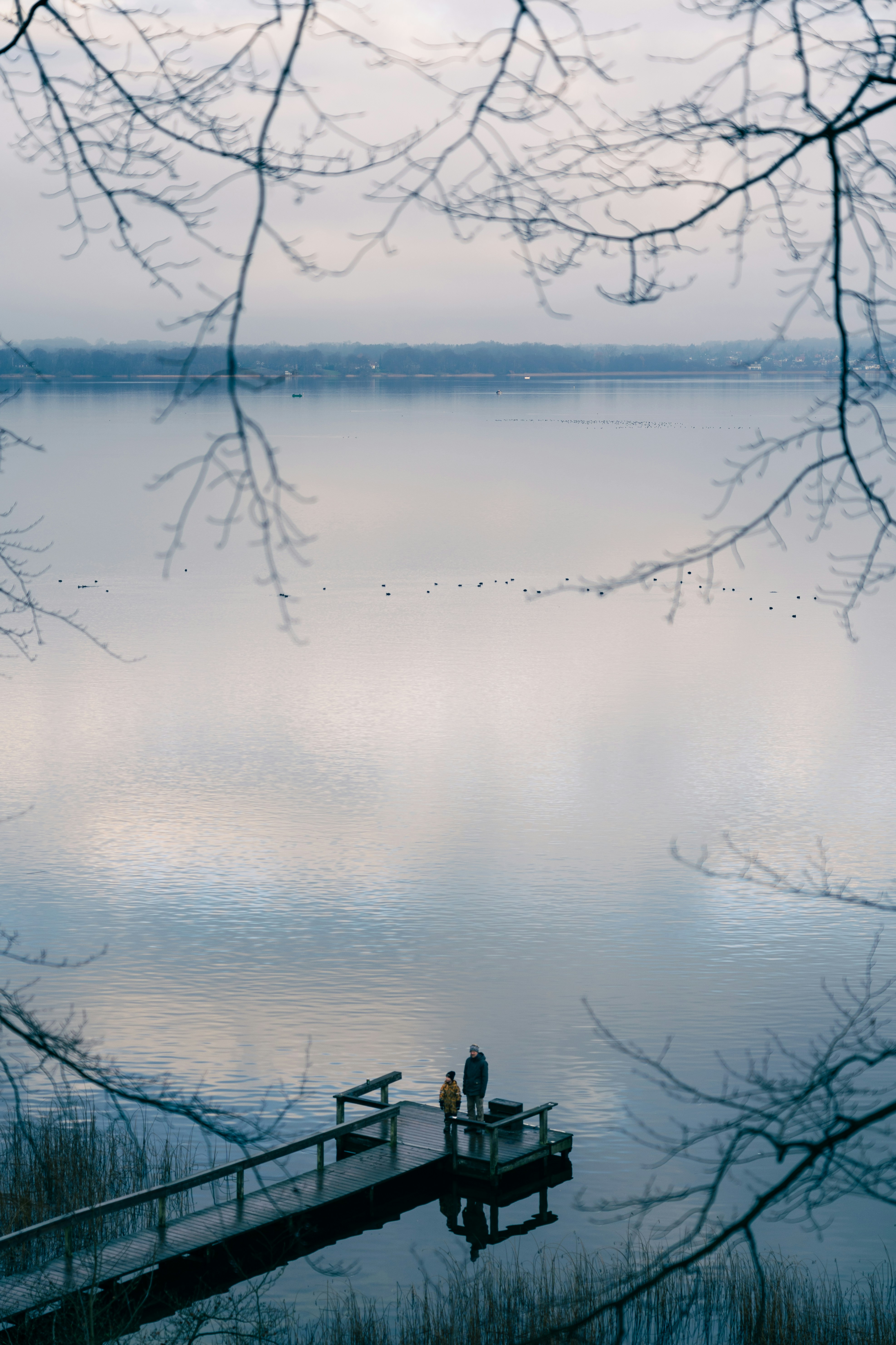 Winter-Lake Quiet: Two Figures at the End of a Wooden Pier