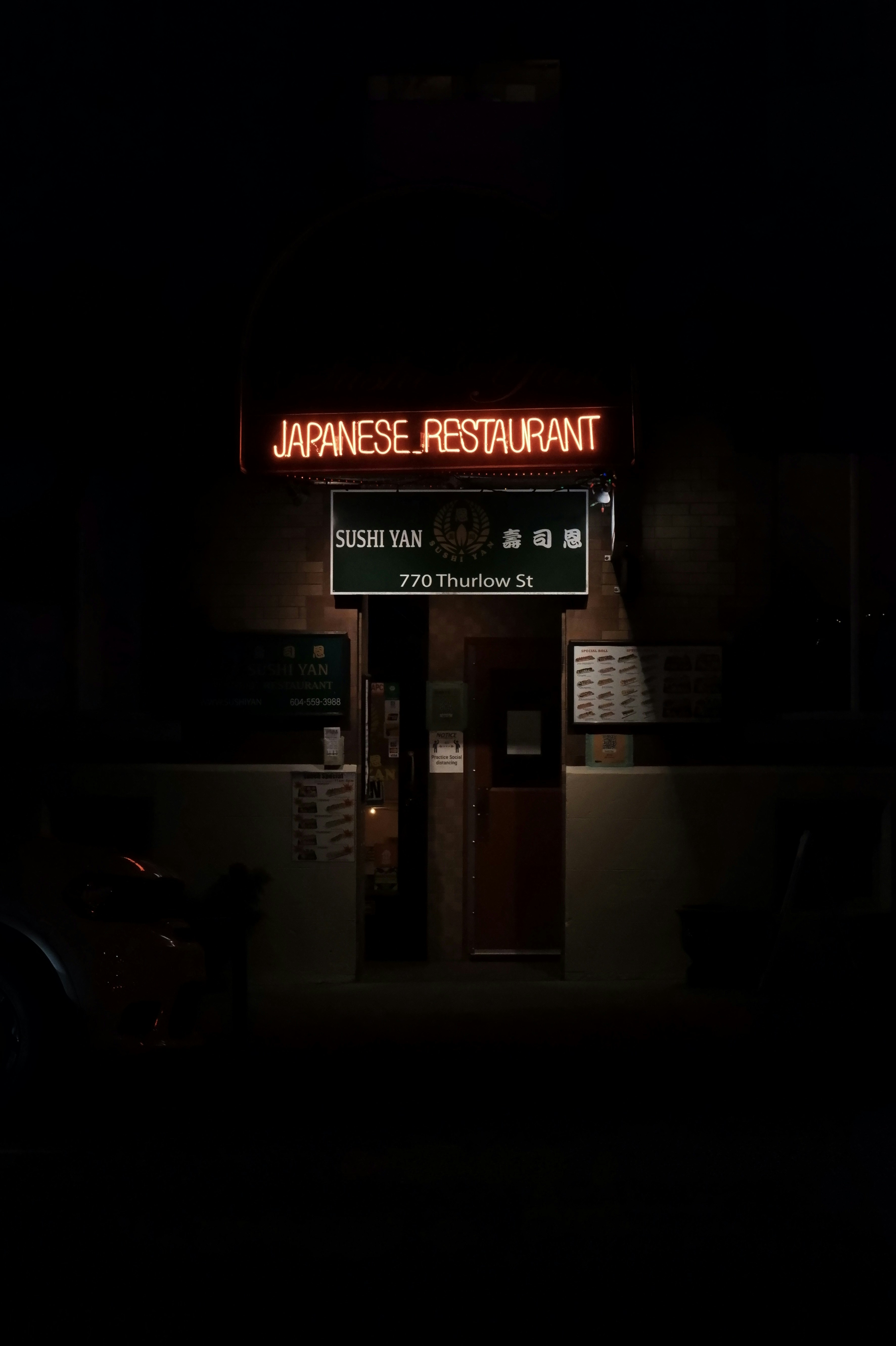 Red Neon Over Sushi Yan: Nighttime doorway on Thurlow Street