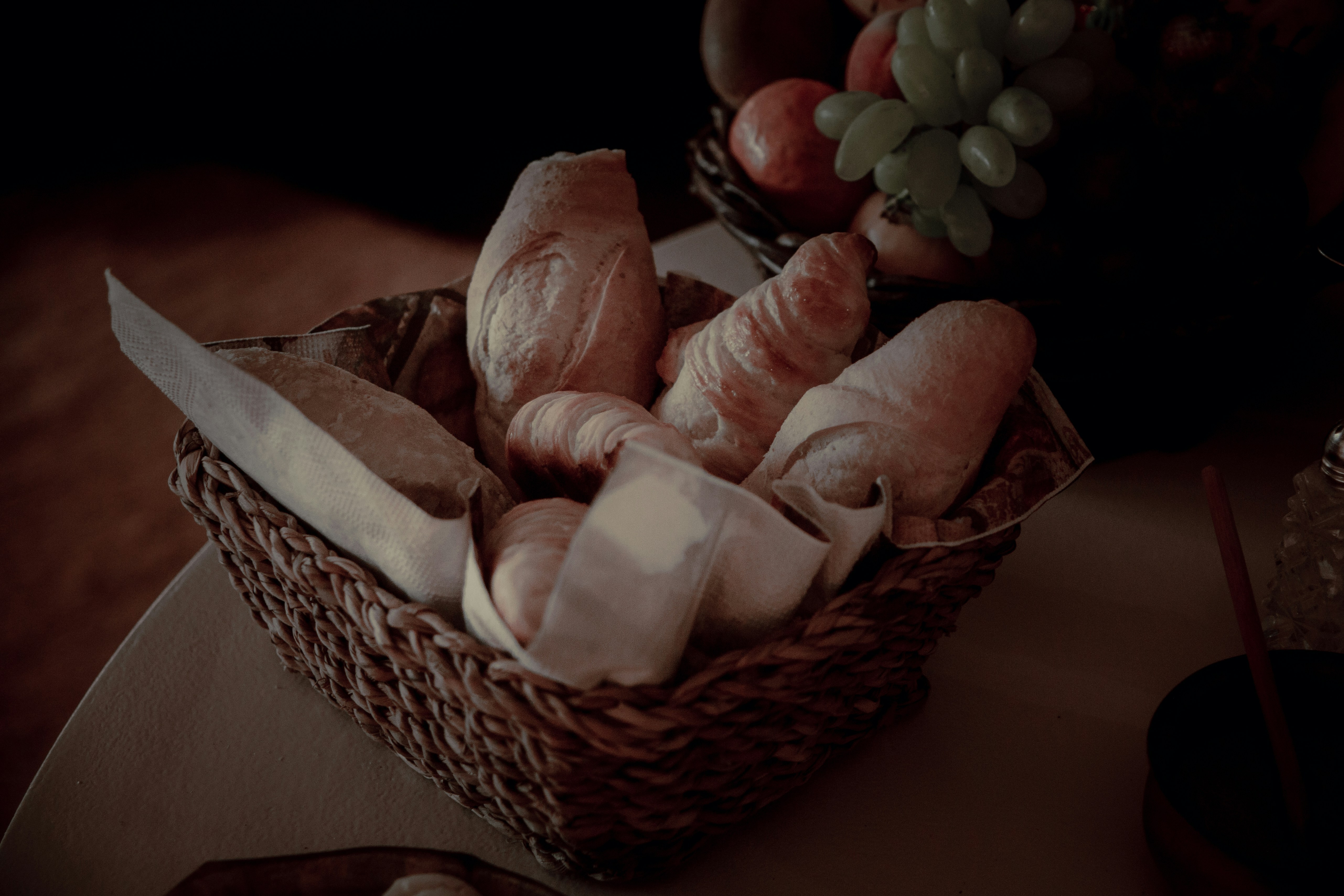 Crust and Quiet Glow: A Rustic Bread Basket on a Dim Table