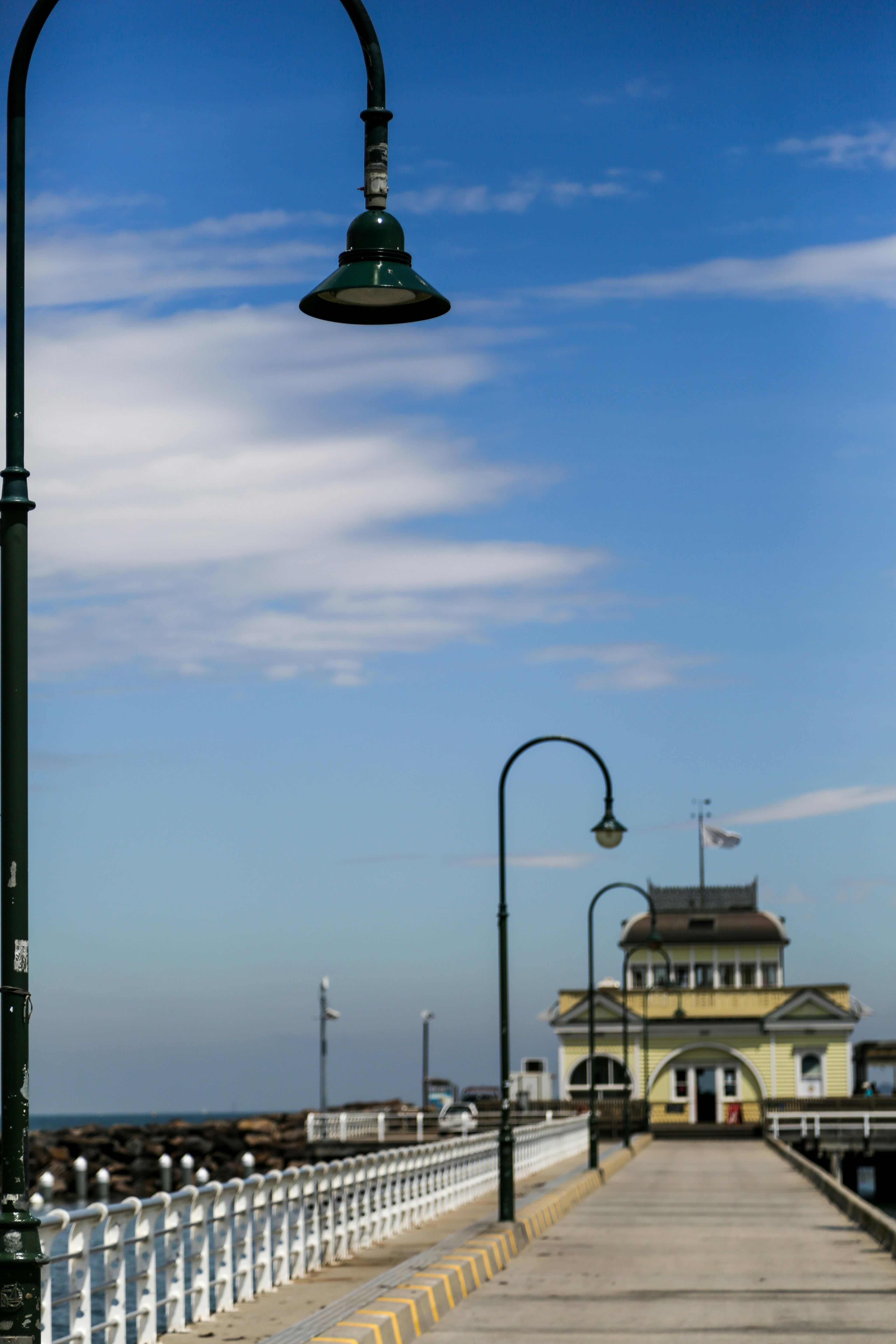 Green Lamps Along the Pier: Path to a Seaside Pavilion