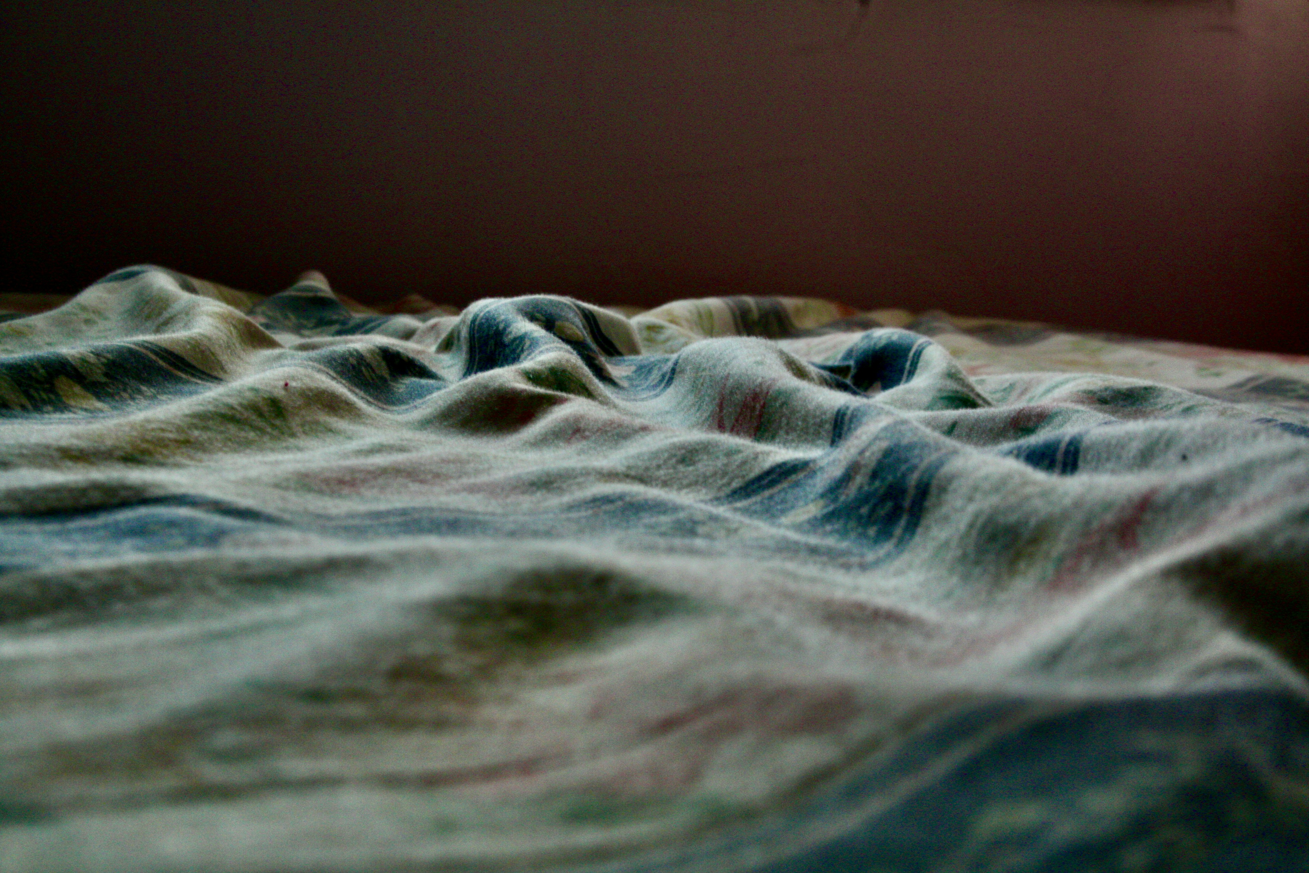 Low-Angle View: Quiet Ridges of a Wrinkled Duvet