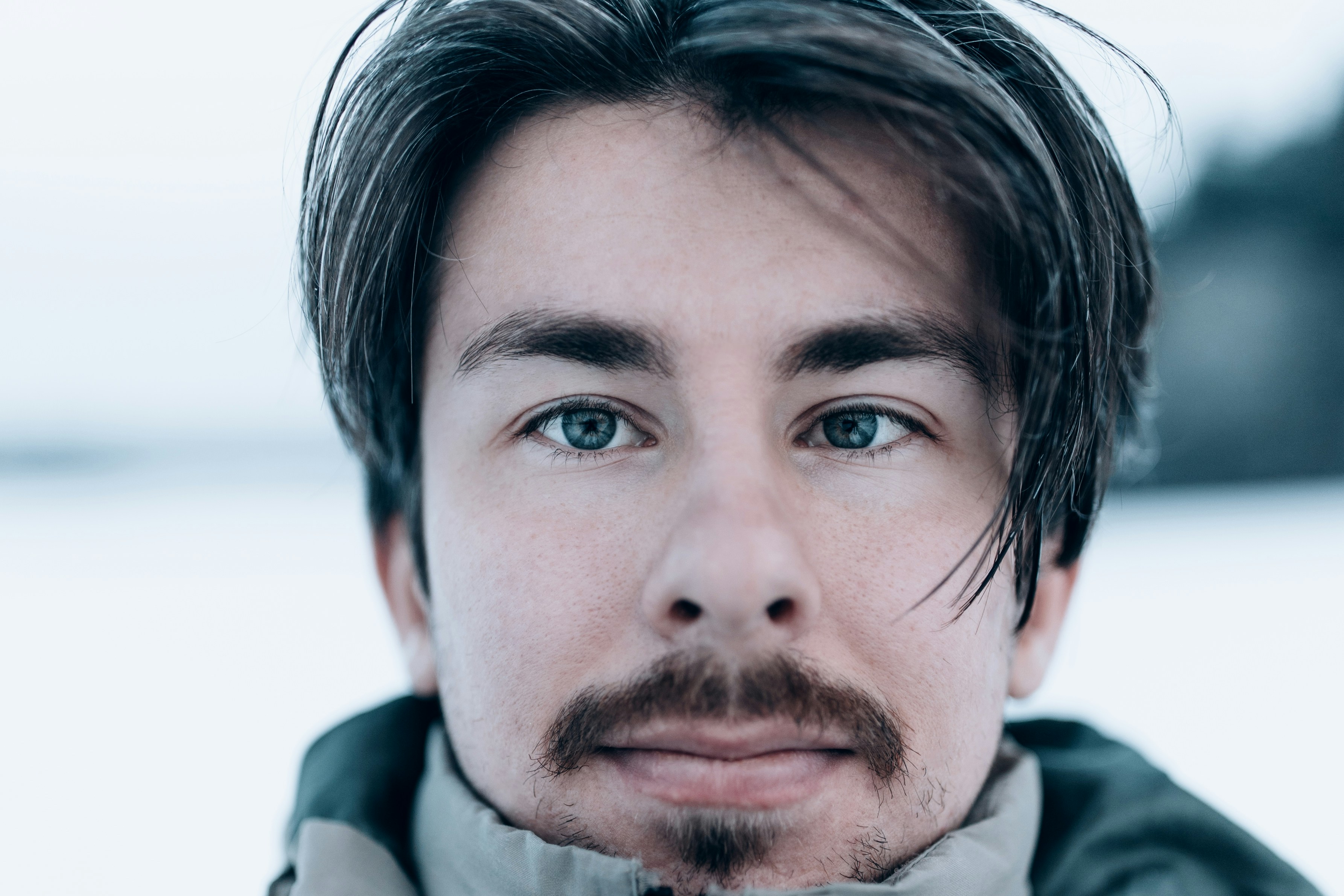 Ice-Blue Gaze: A Wind-Swept Close-Up Portrait