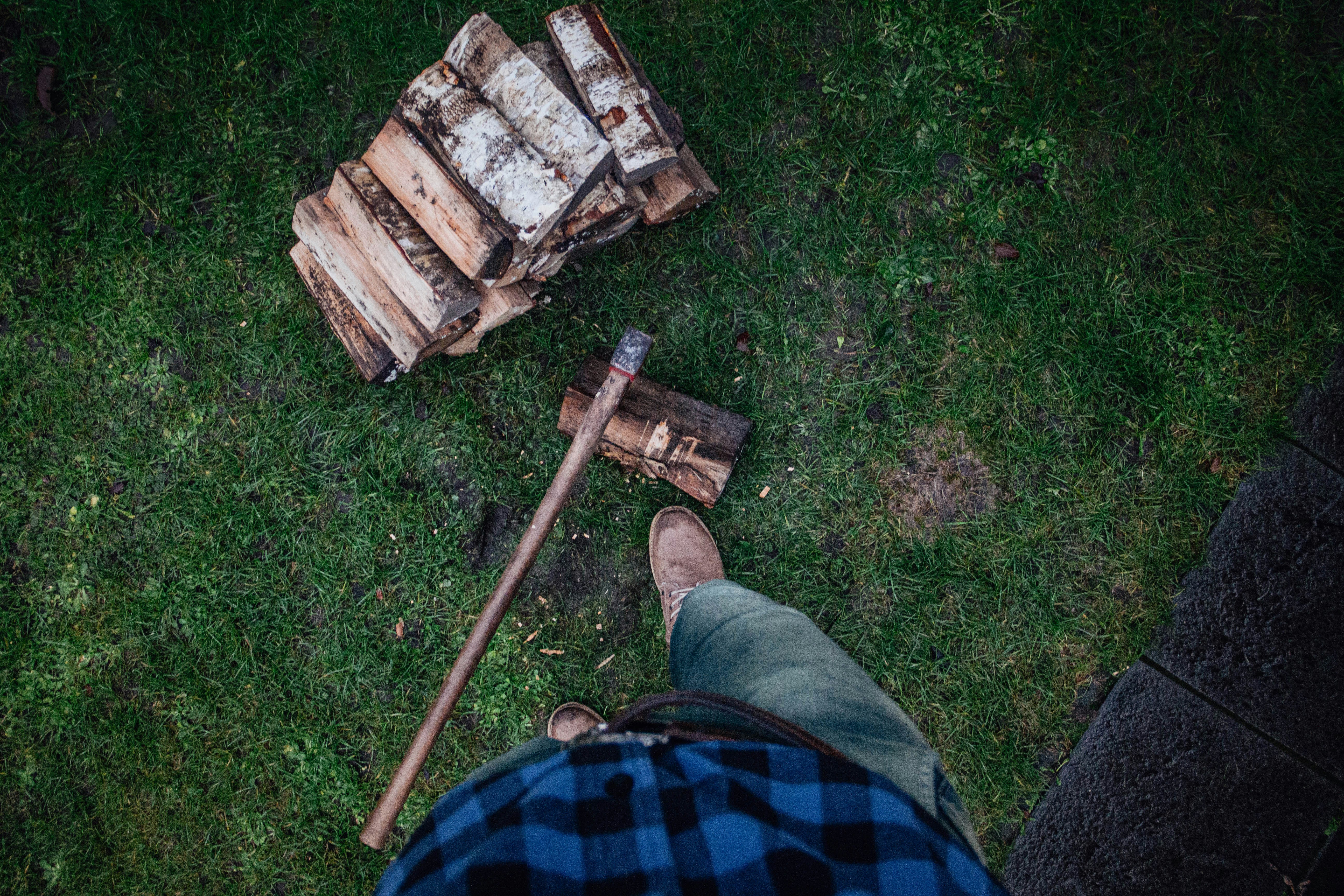 Low-Angle Cartography: Logs, Axe, and Green Grass