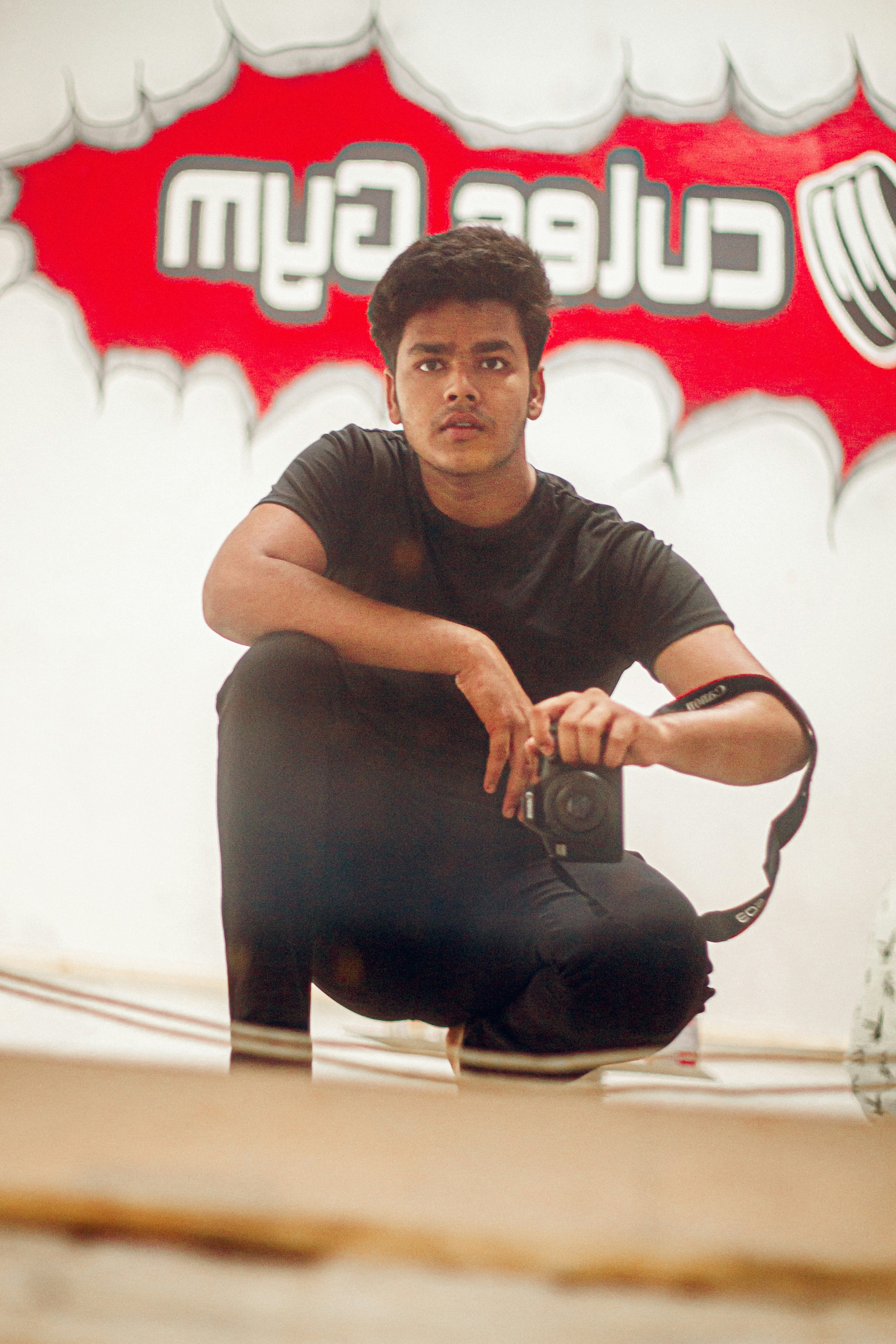 Man in black crew neck t-shirt sitting on white floor tiles photo ...