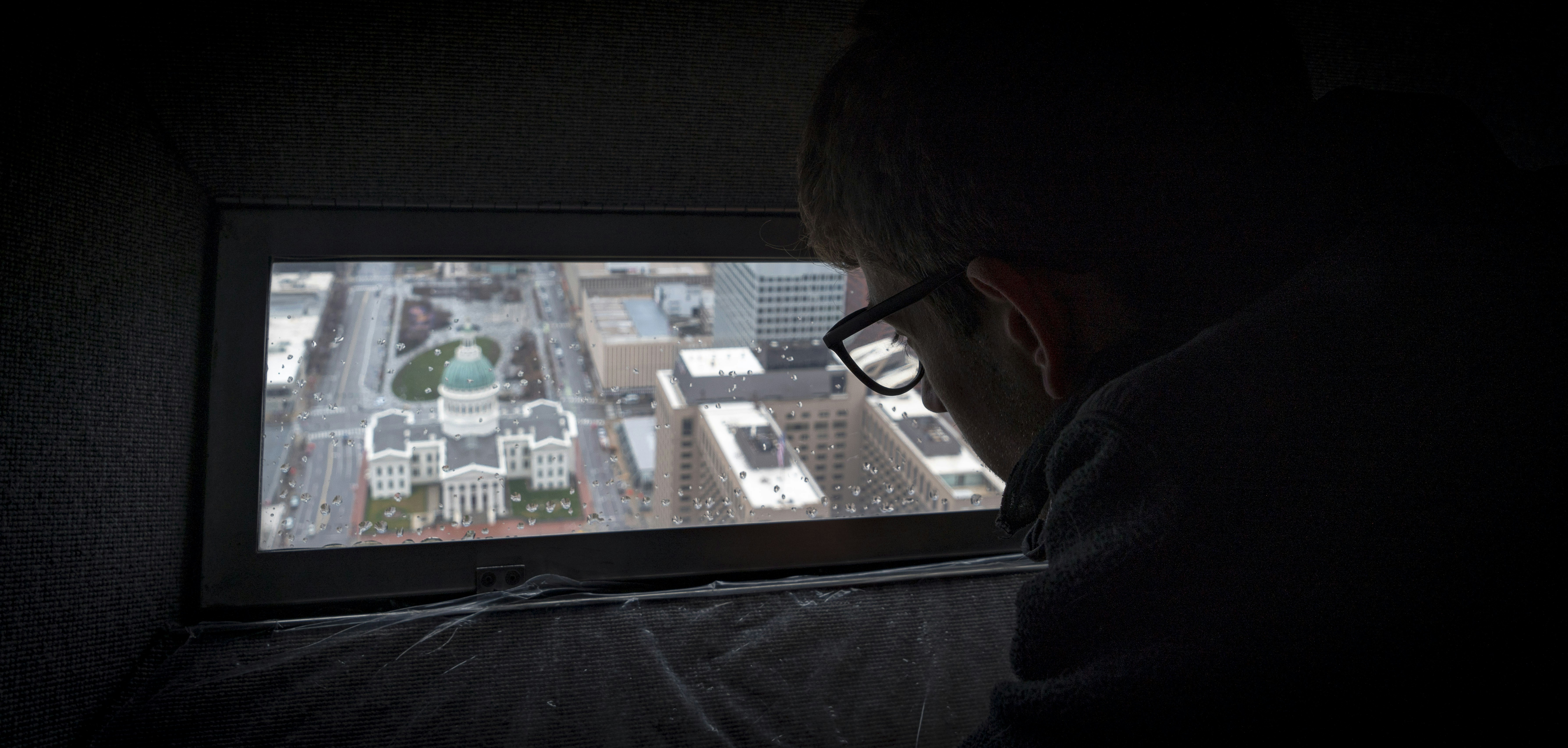 Window View: The Green-Domed City Hall Framed by a Quiet Rooftop Perspective