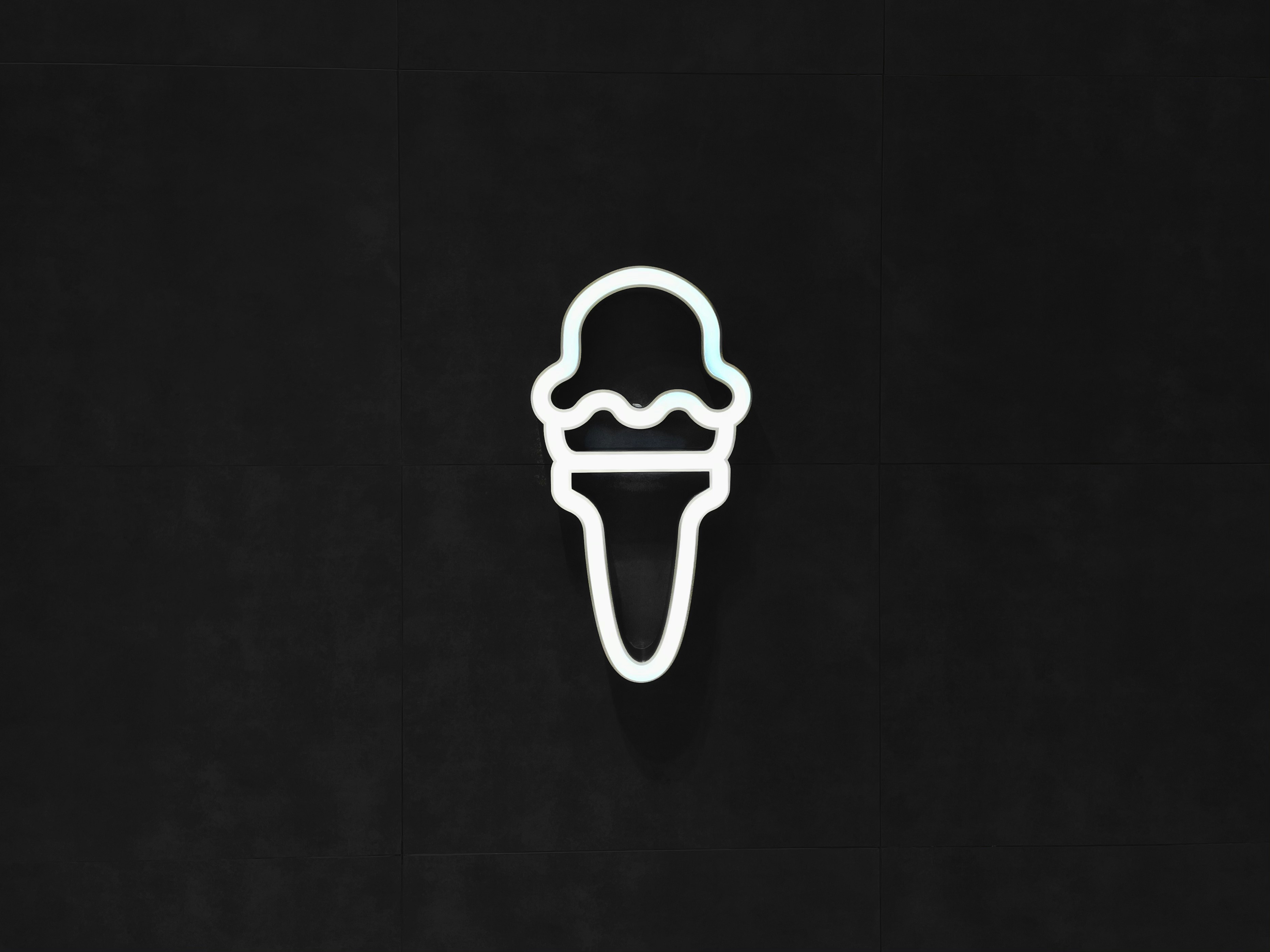 Centered White Line-Art Ice Cream Cone Logo on Matte Black