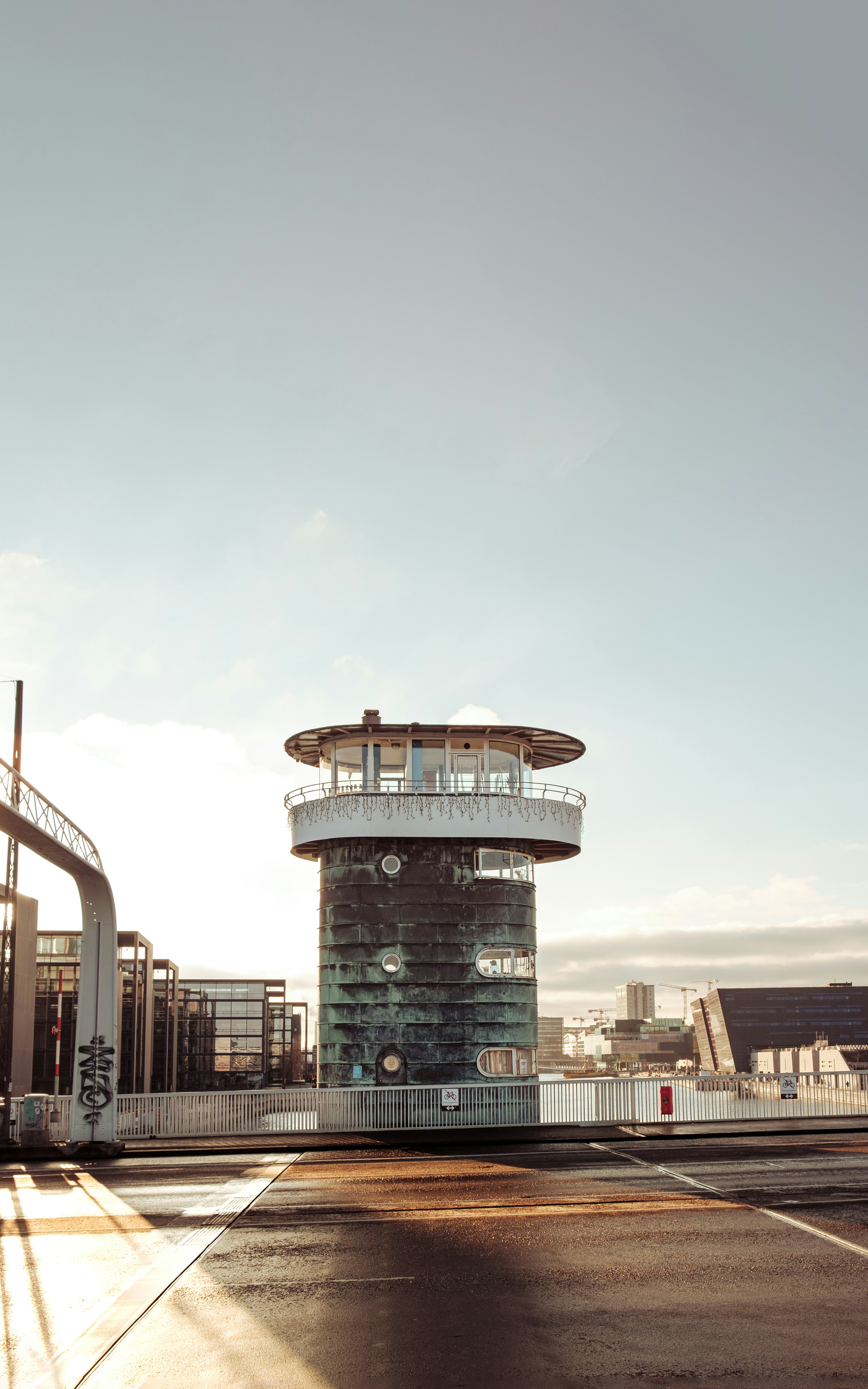 Rooftop Roundhouse: Circular Watchtower Against the City Sky