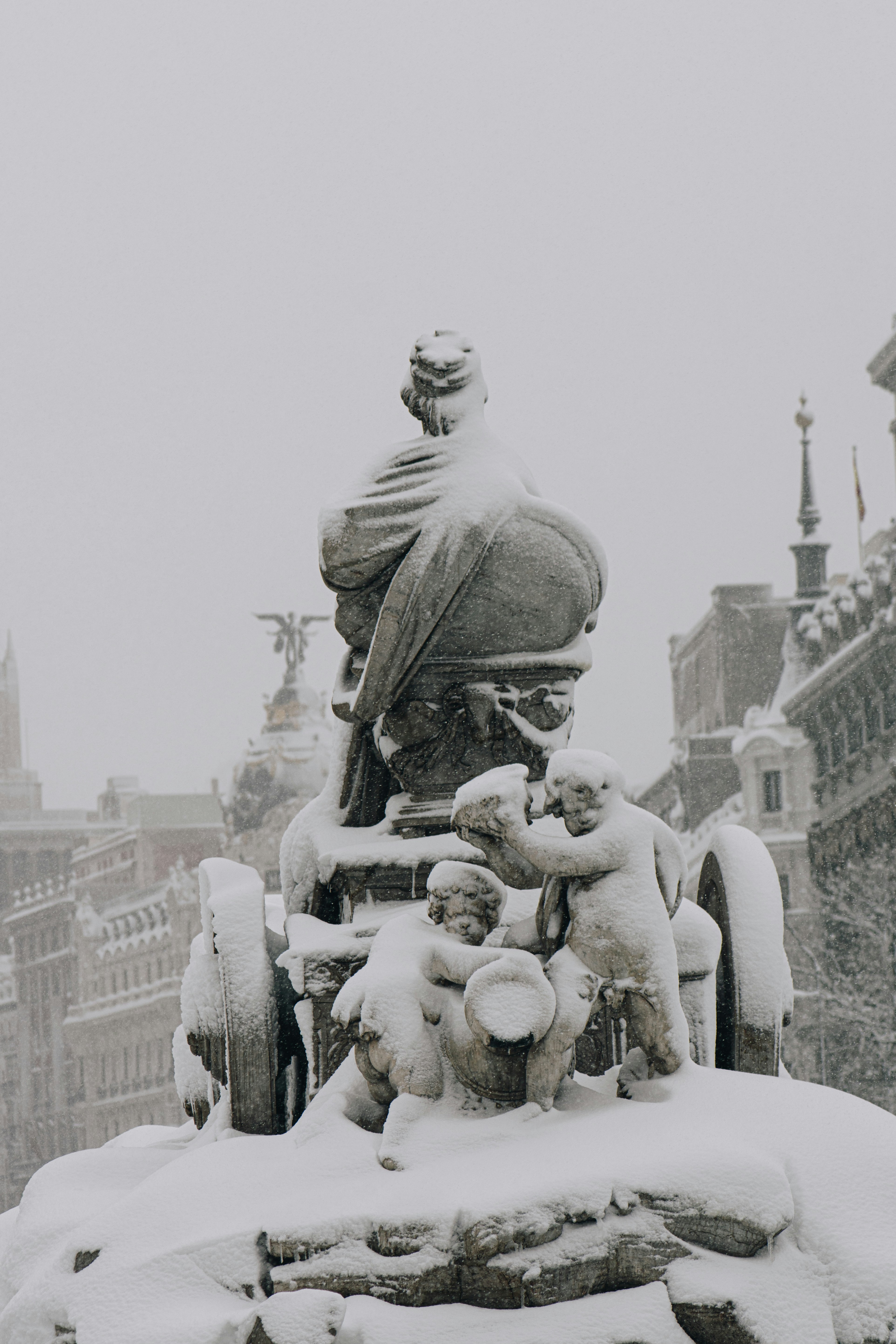 statue of man sitting on chair