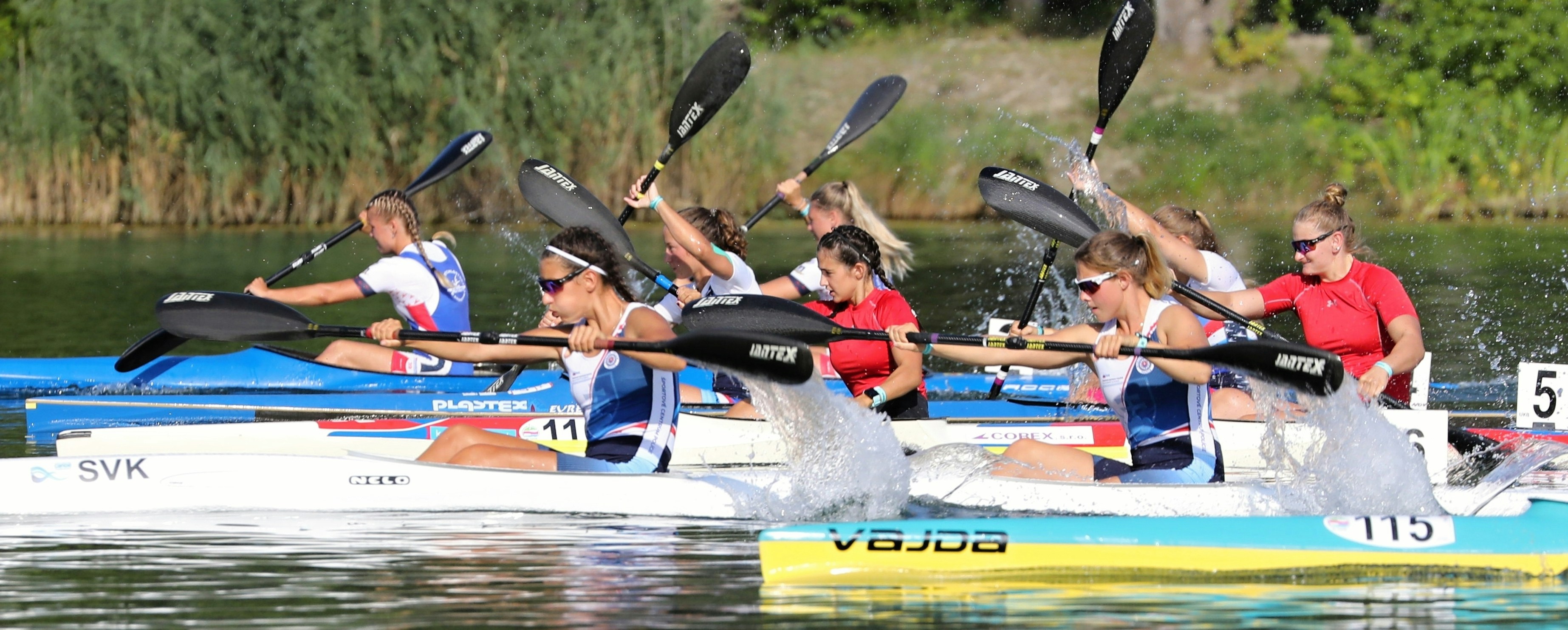 Paddlers in Sync: A Sprint of Color and Water