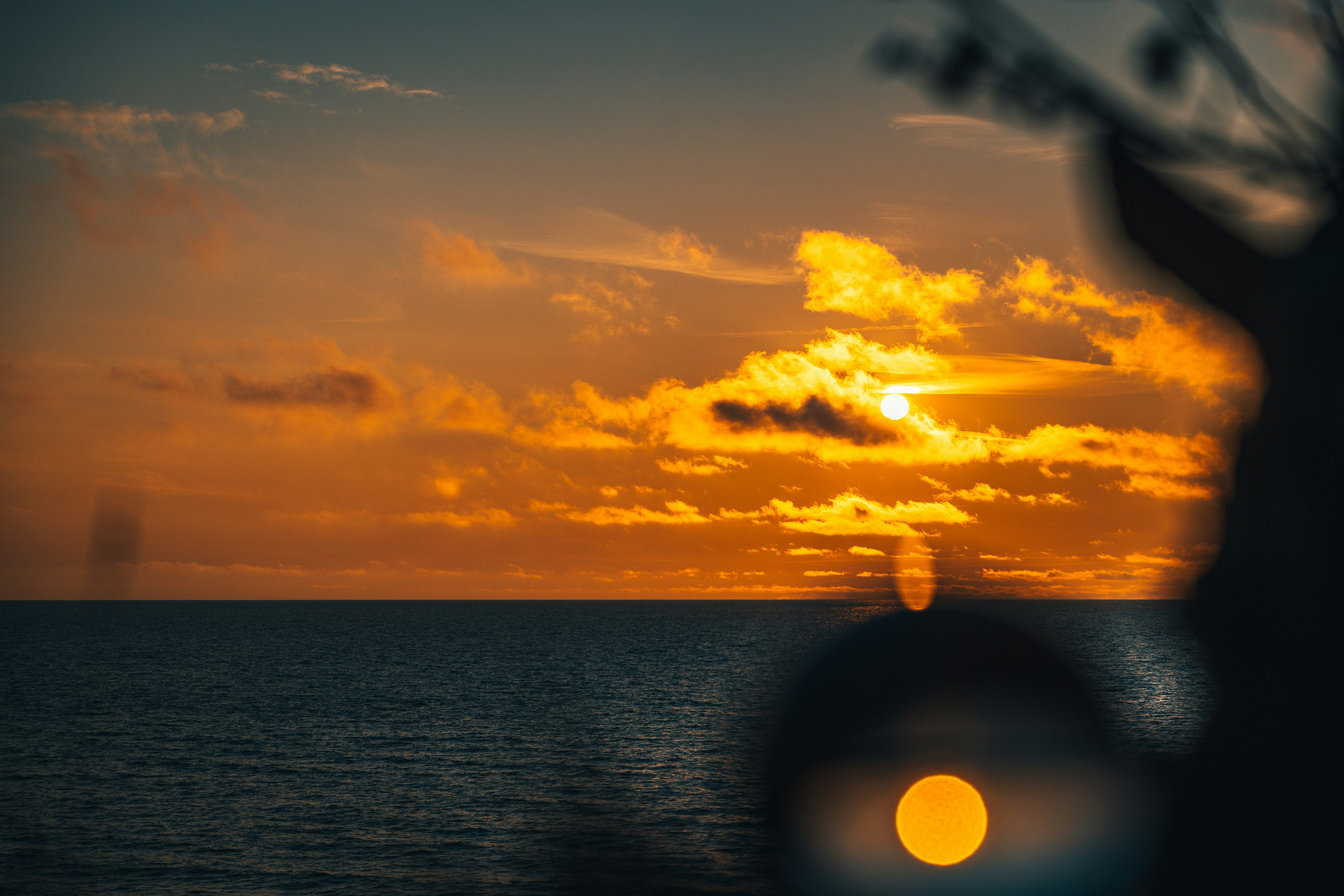 Sunset Lens: A Blurred Horizon and Golden Orbs