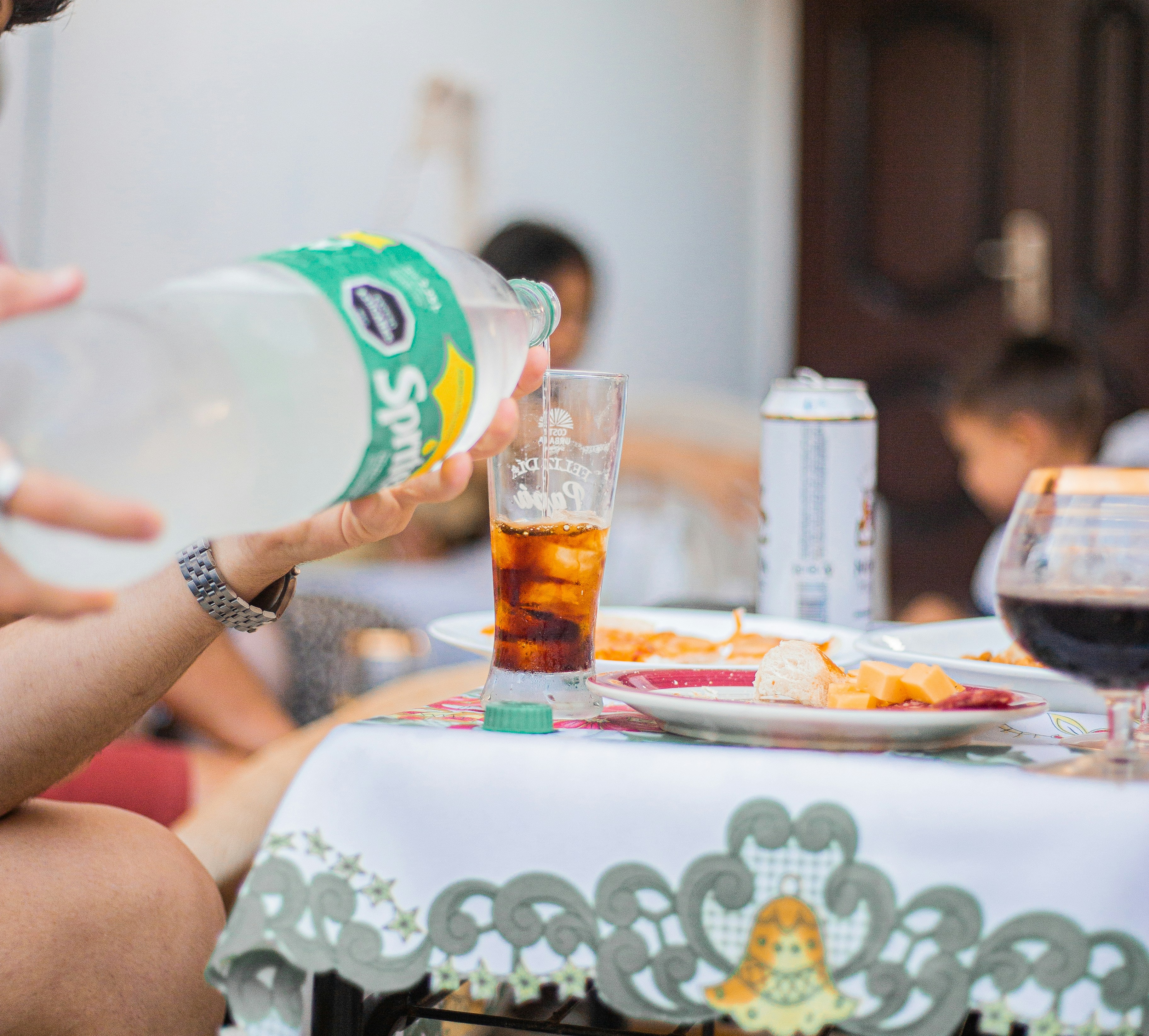 Pouring Moments: Glasss, Cola, and Tablecloth Details