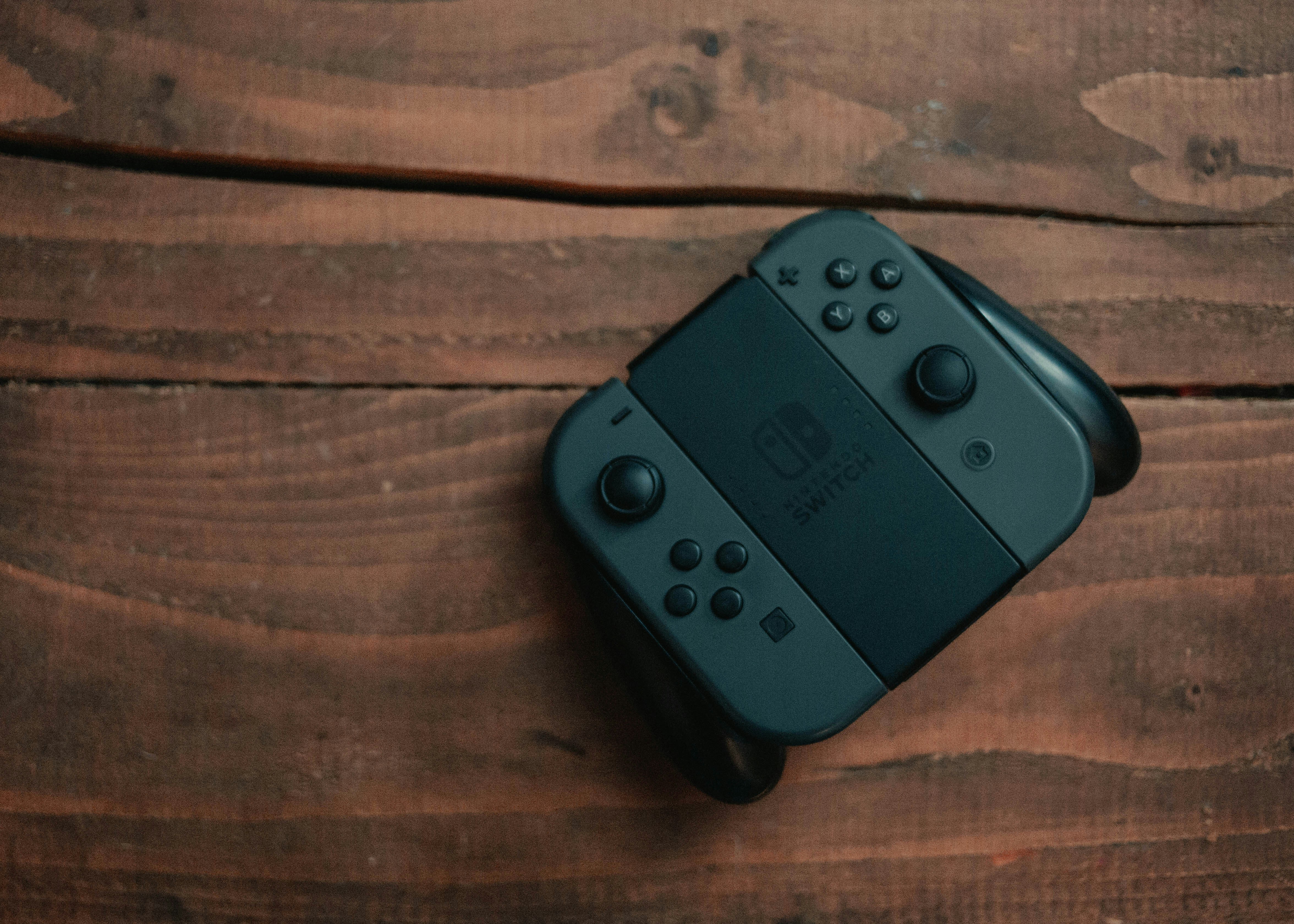 Blue Joy-Con Grip on Weathered Wood: A Quiet Hardware Moment