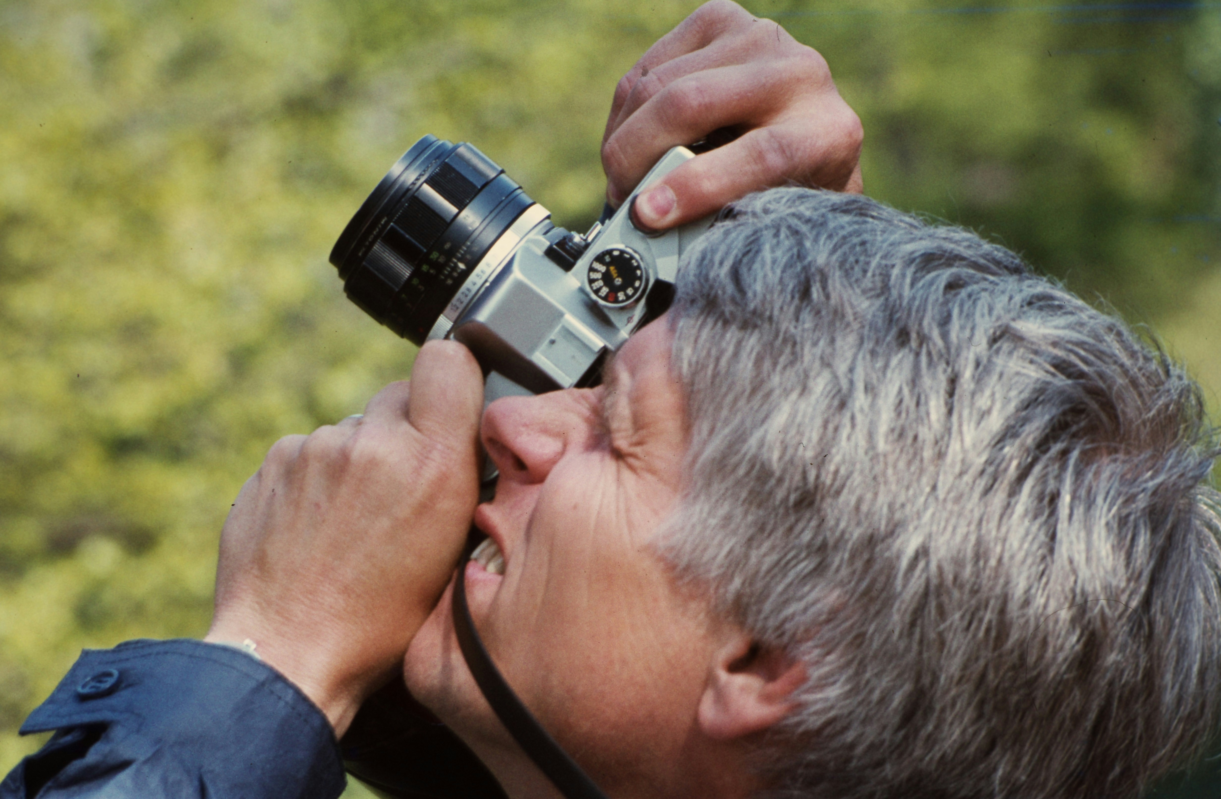 Close-up of a photographer in action with a vintage-style camera