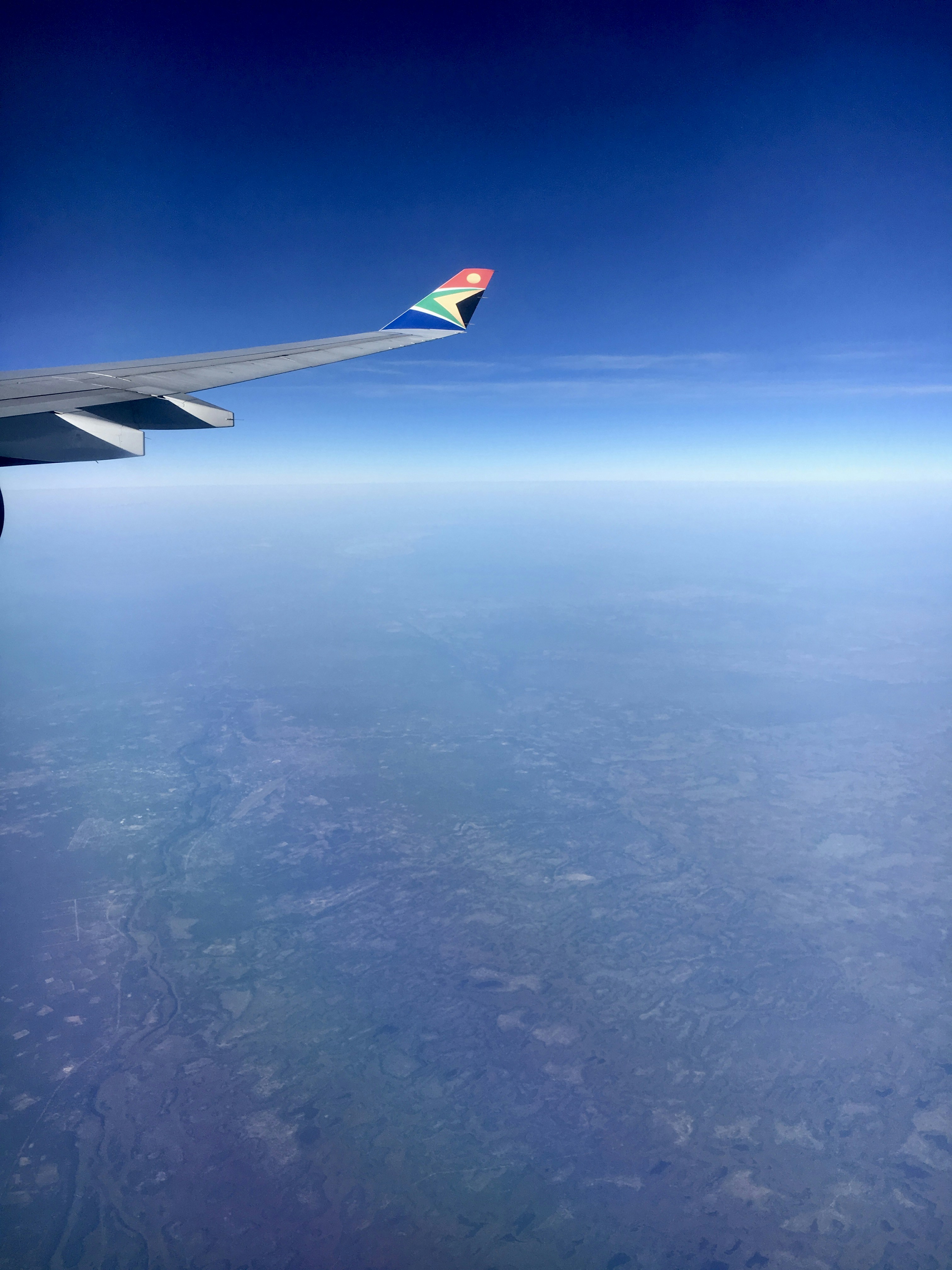 Colorful Winglet Against an Expansive Blue: A Quiet High-Altitude View