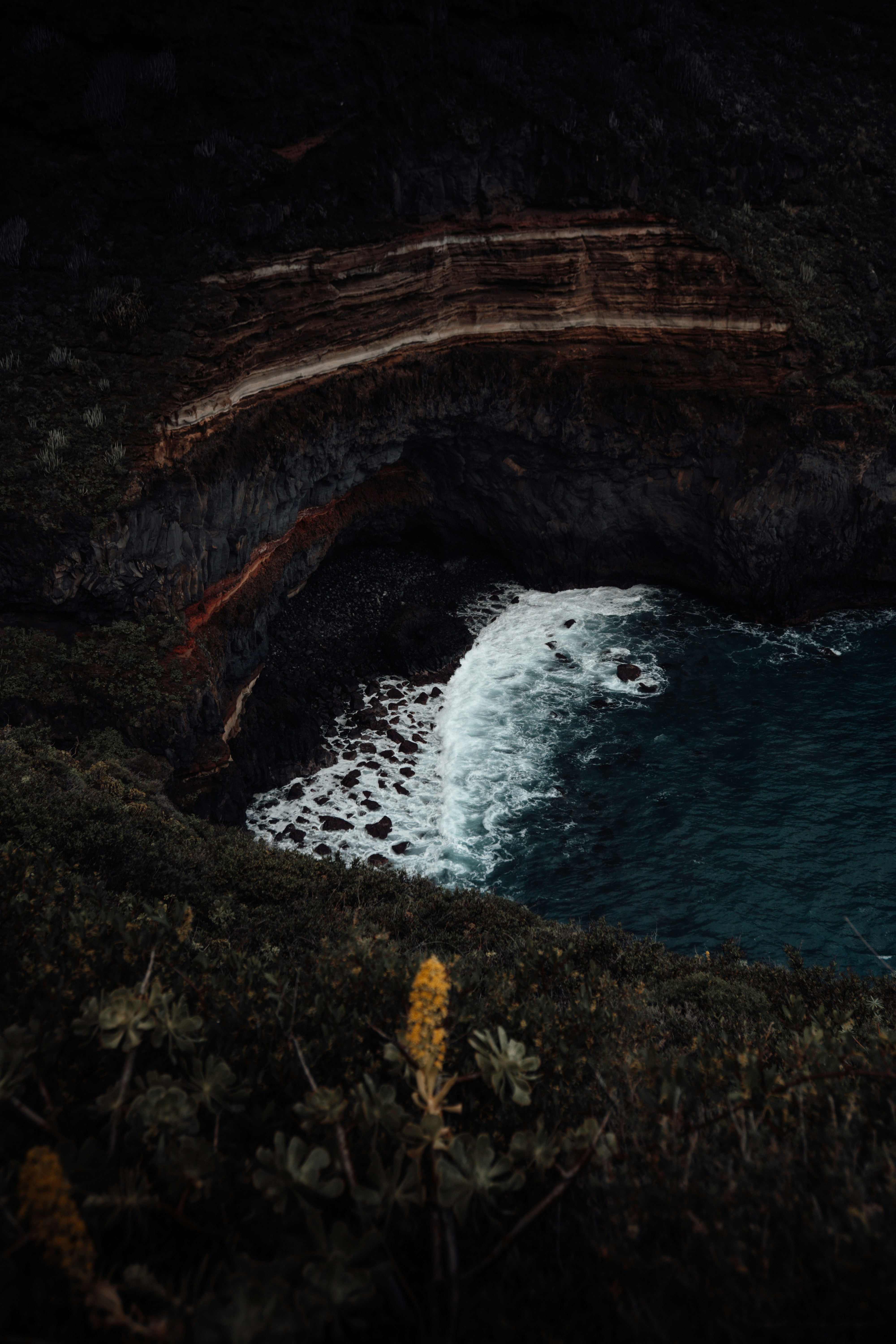 Cove Curve: A Shadowed Cliff Framing Turquoise Surf