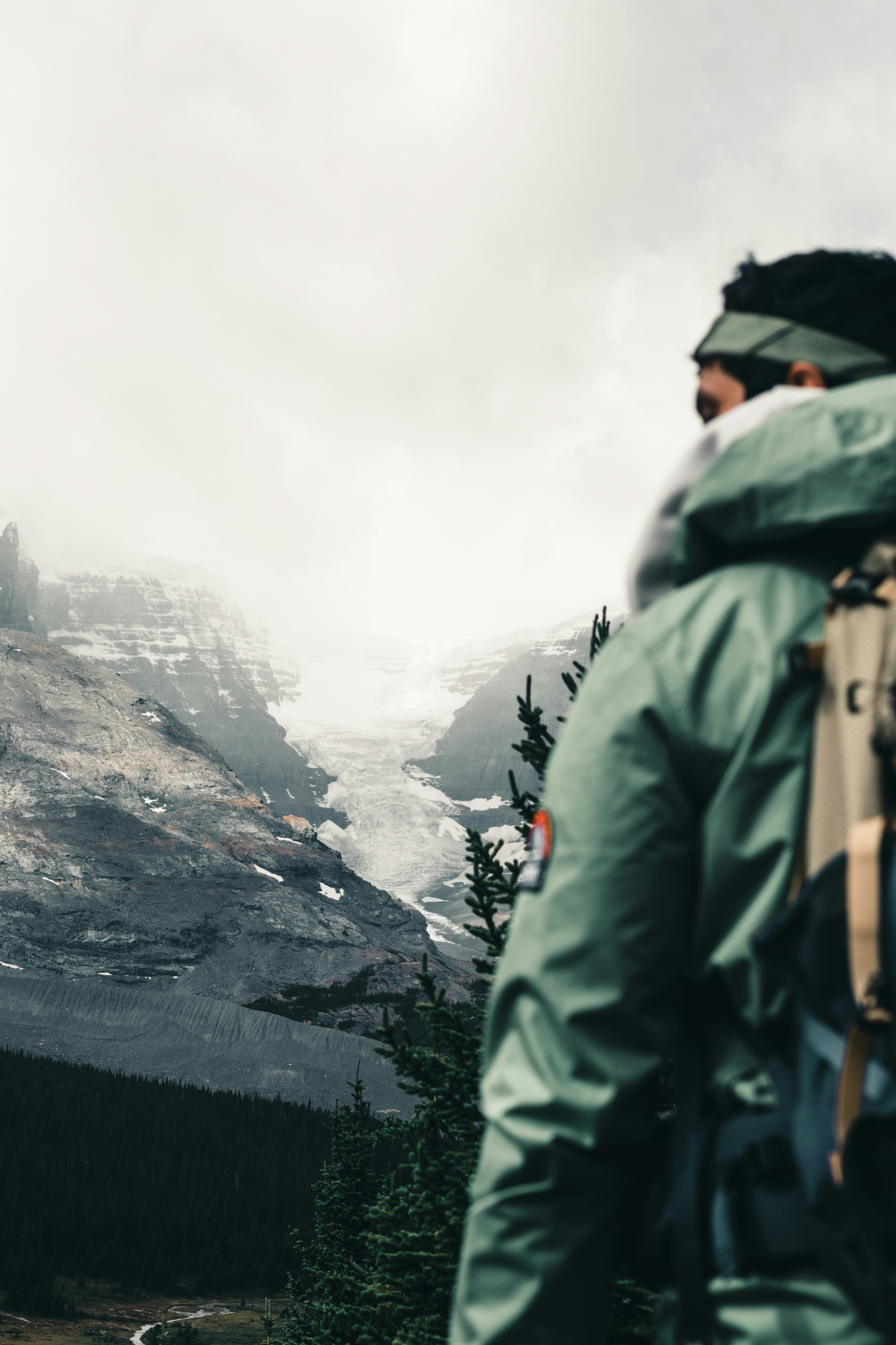 Ridgebound Trekker: A Hiker Framed Against Snowlit Valleys