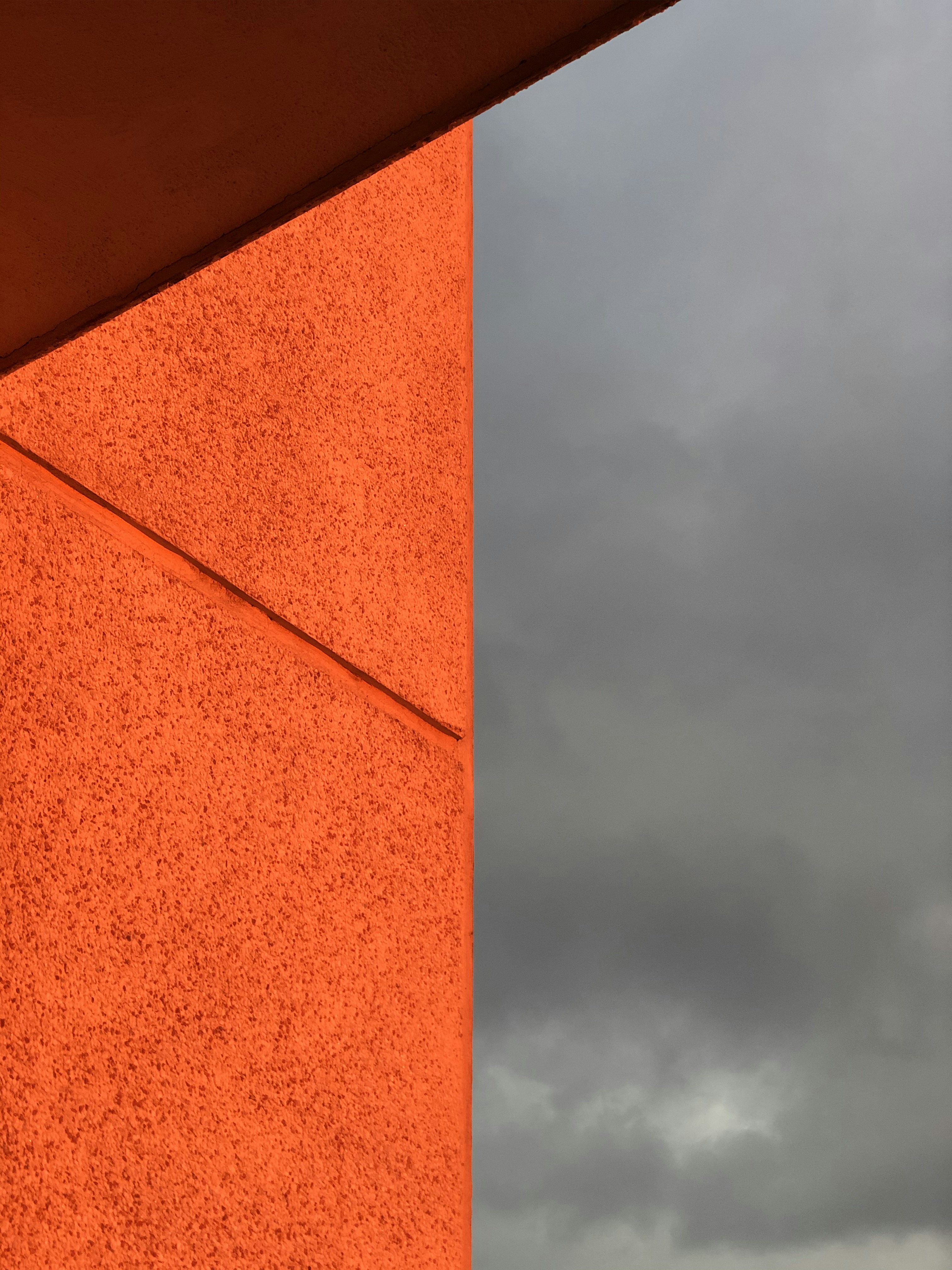 Crimson Facade Fractured by a Stormy Sky