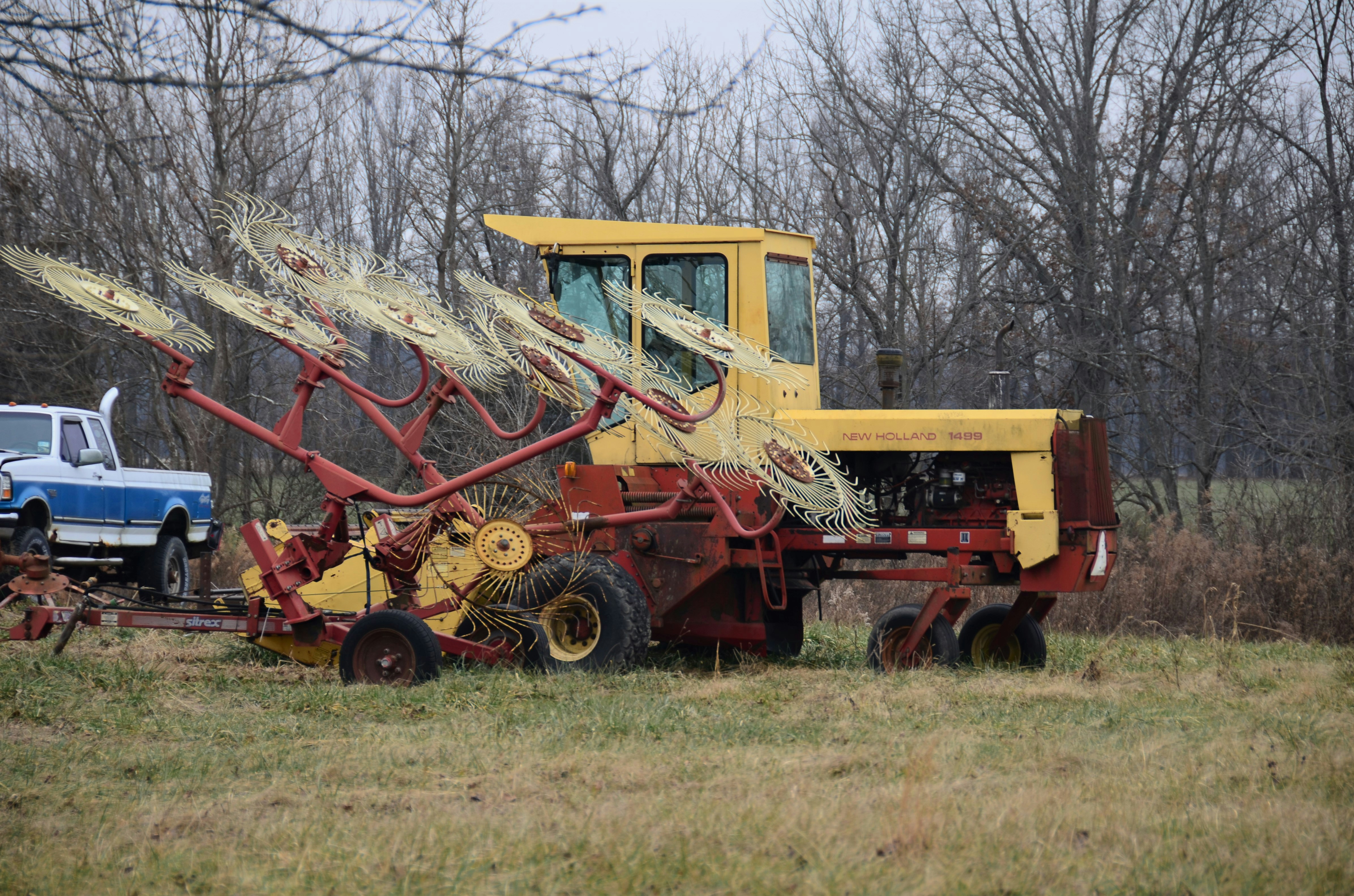 Quiet Giant in Yellow: A Vintage Harvester Resting in a Field