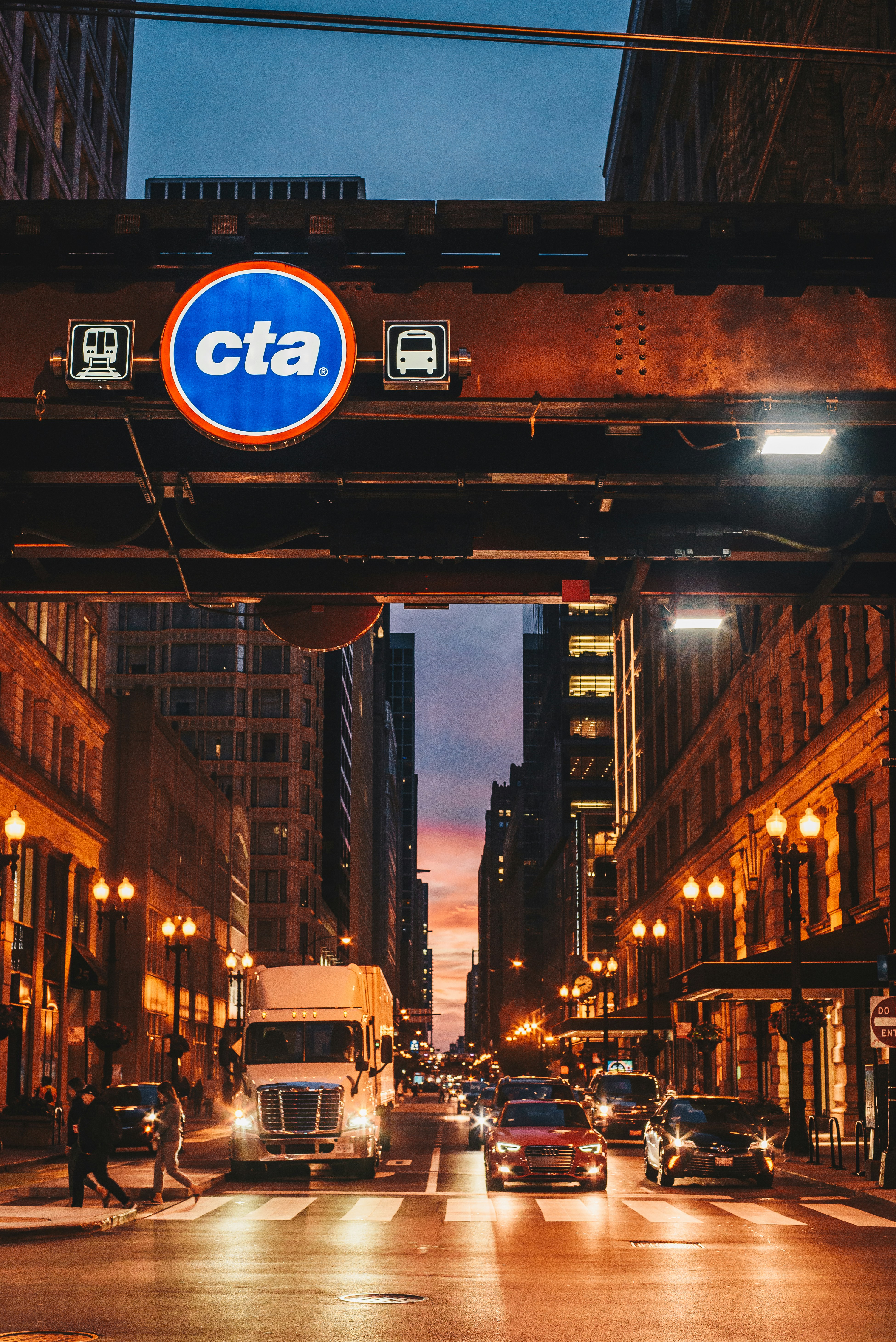 Blue Circle of Transit: A Dusk-Glowing City Street Corridor