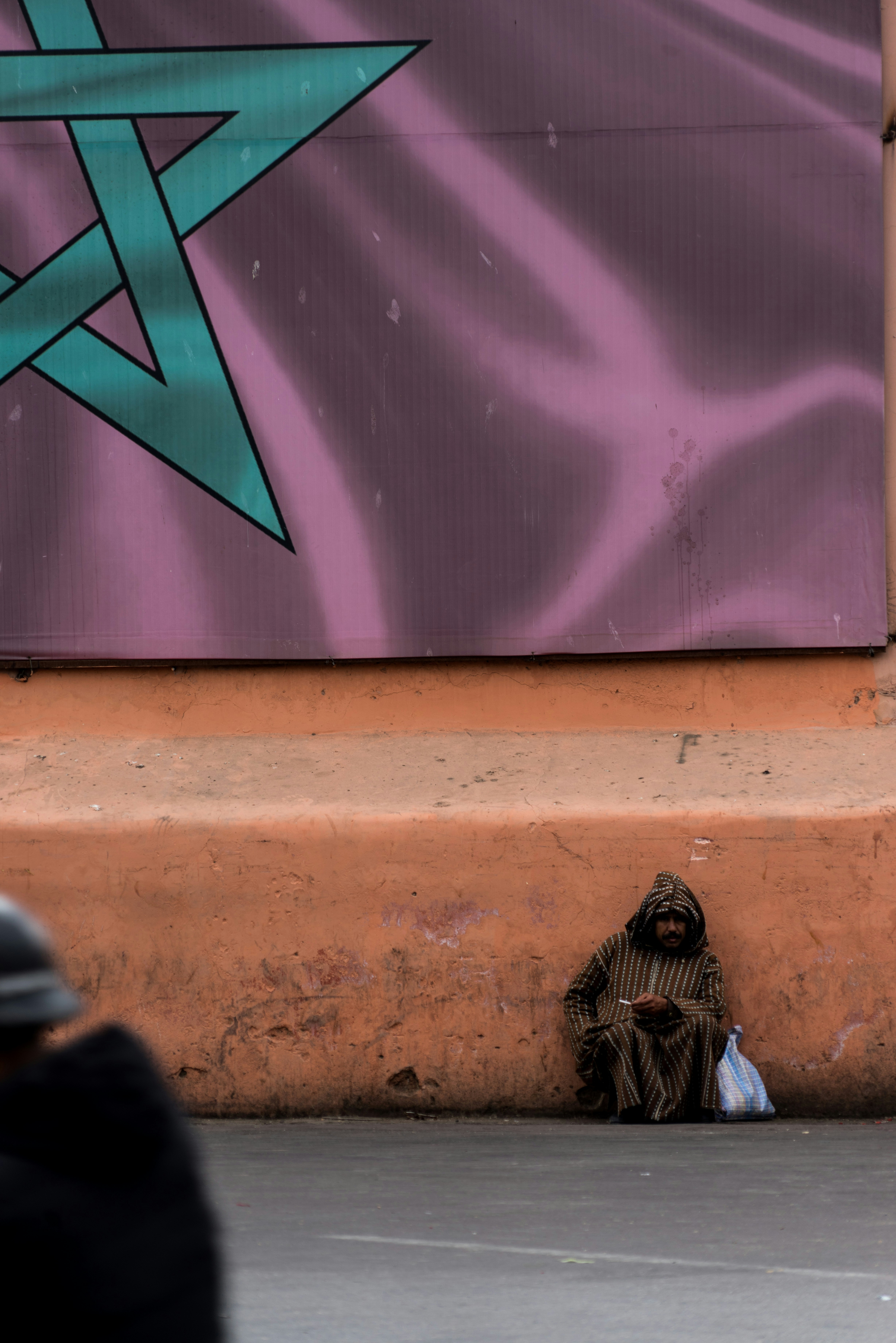 Quiet Portrait by a Teal Star Mural on a Peach Wall