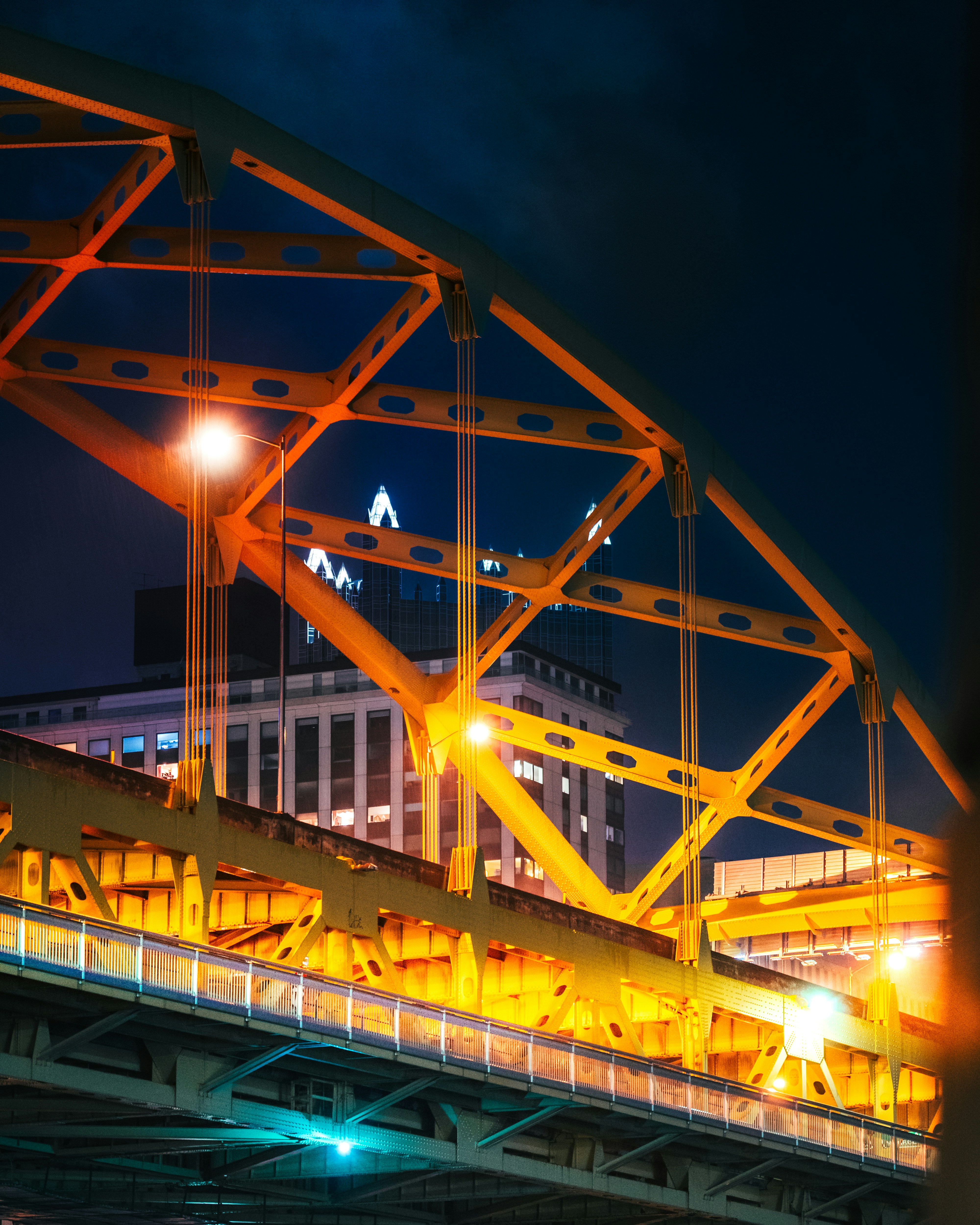 Amber Lattice Over Neon Nights: Night-shot of a Glowing Orange Truss Bridge