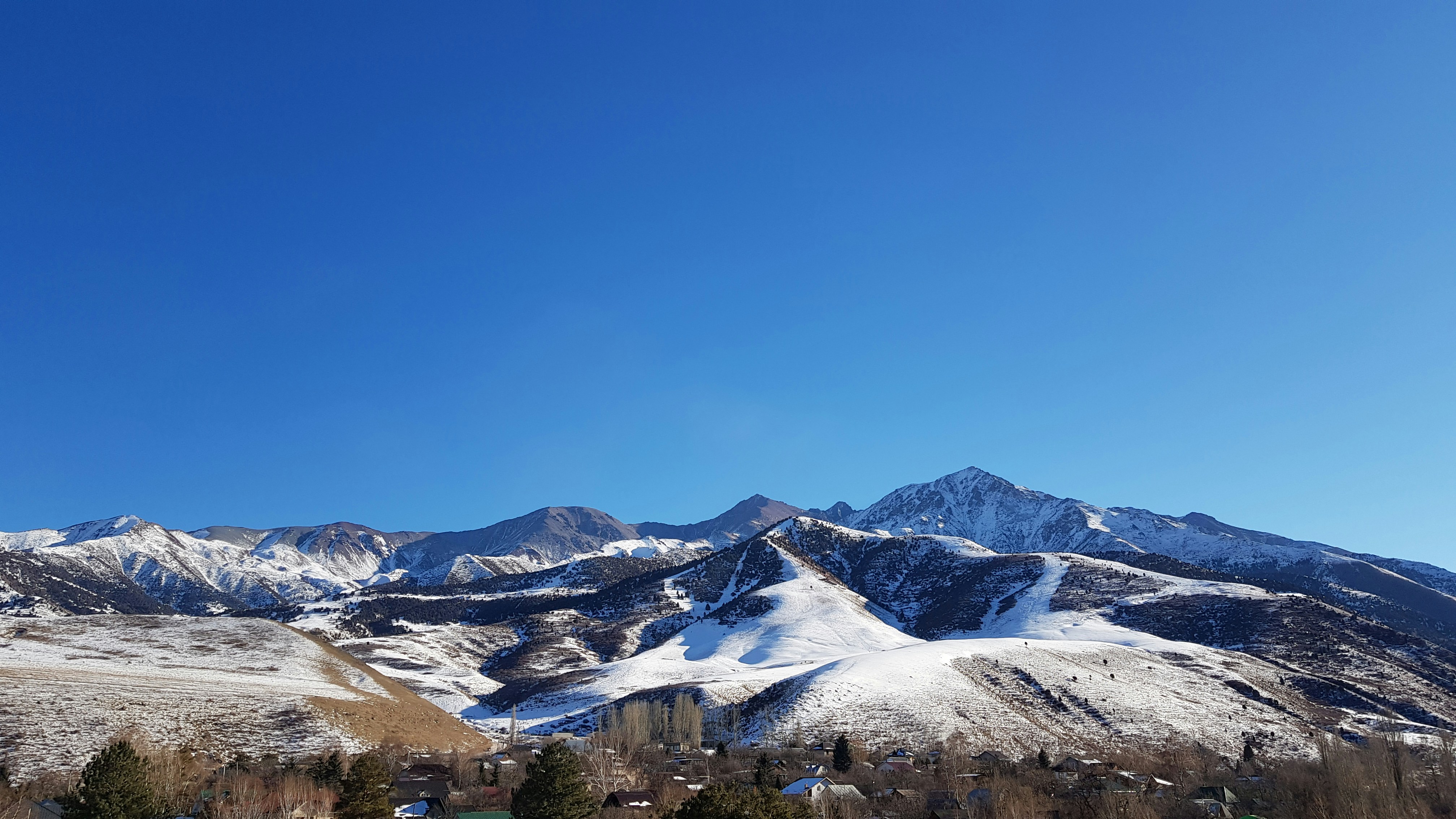 Snow-kissed Ridge Under a Pristine Alpine Sky