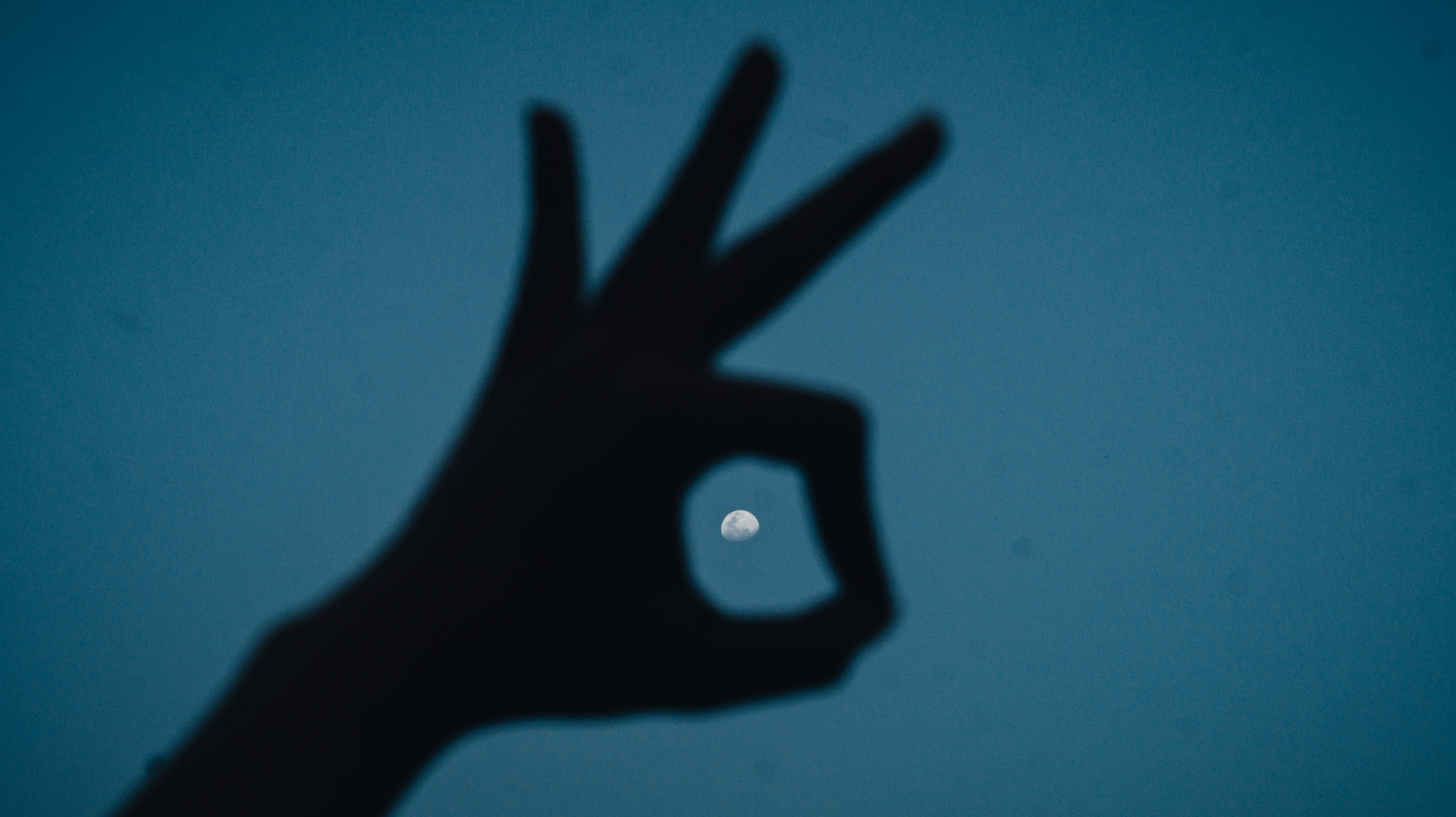 Moon Through a Finger Ring: A Blue Night Silhouette