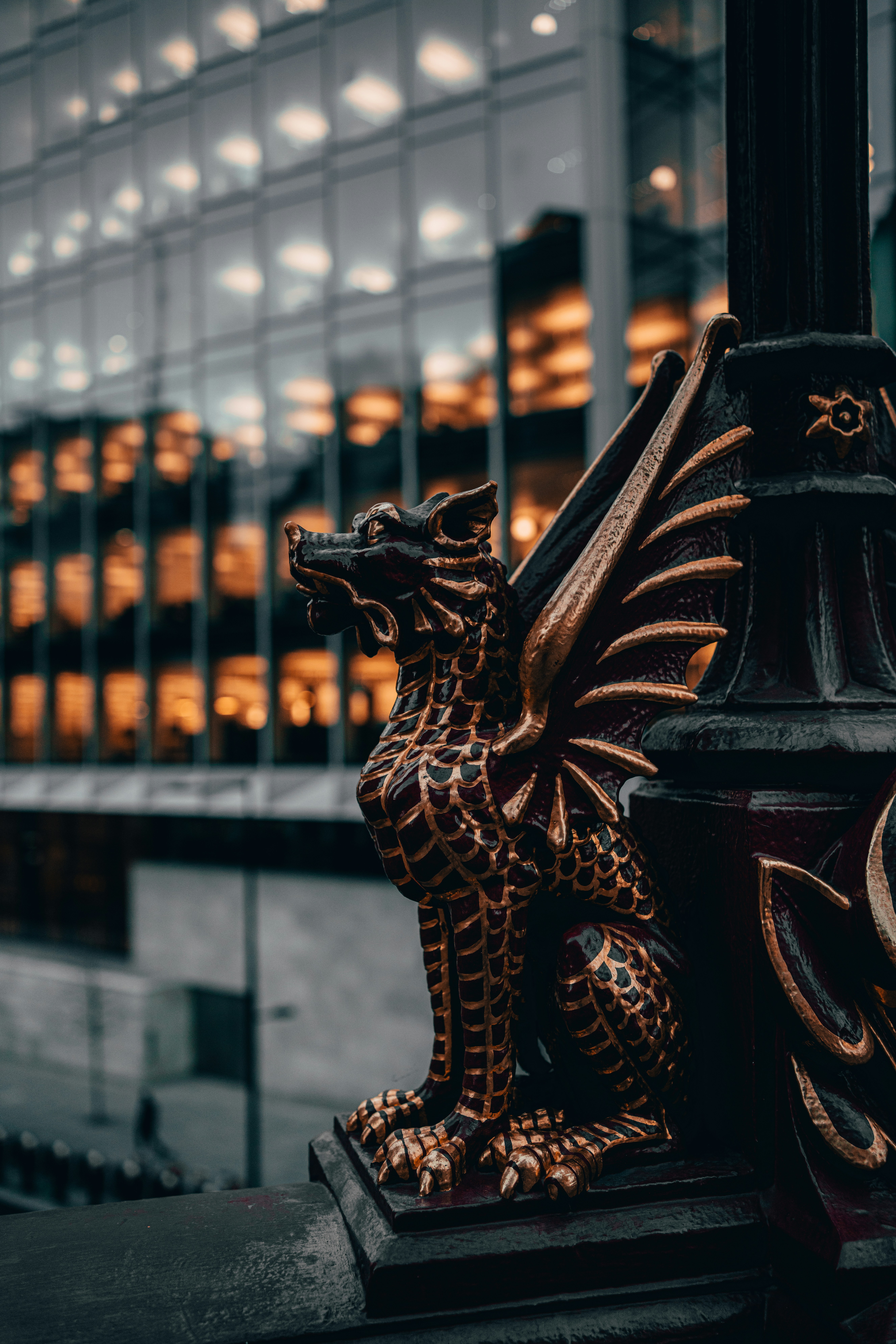 Bronze Dragon Sentinel at Twilight Over a Glass-Fronted City