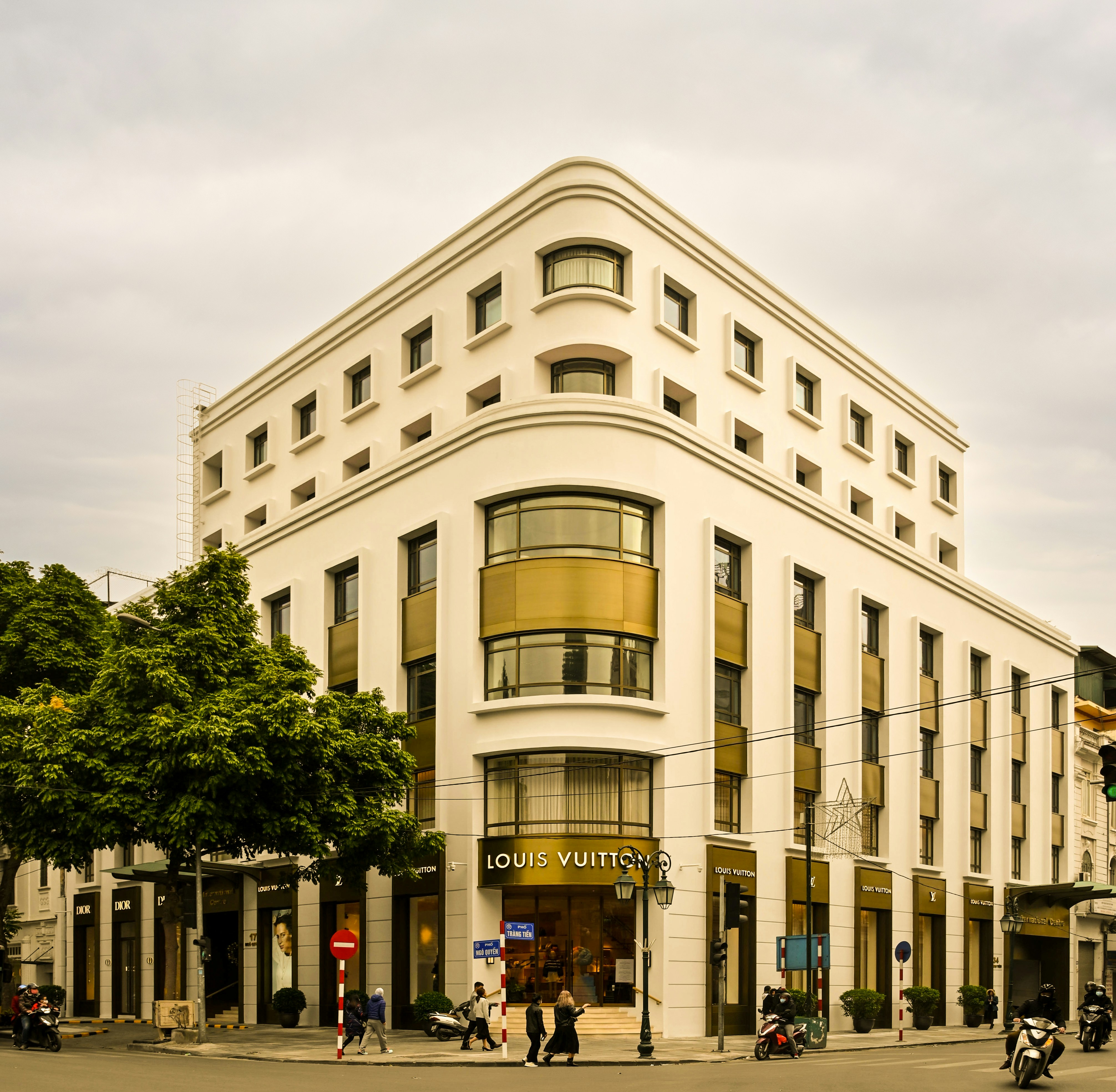 people walking on street near white concrete building during daytime