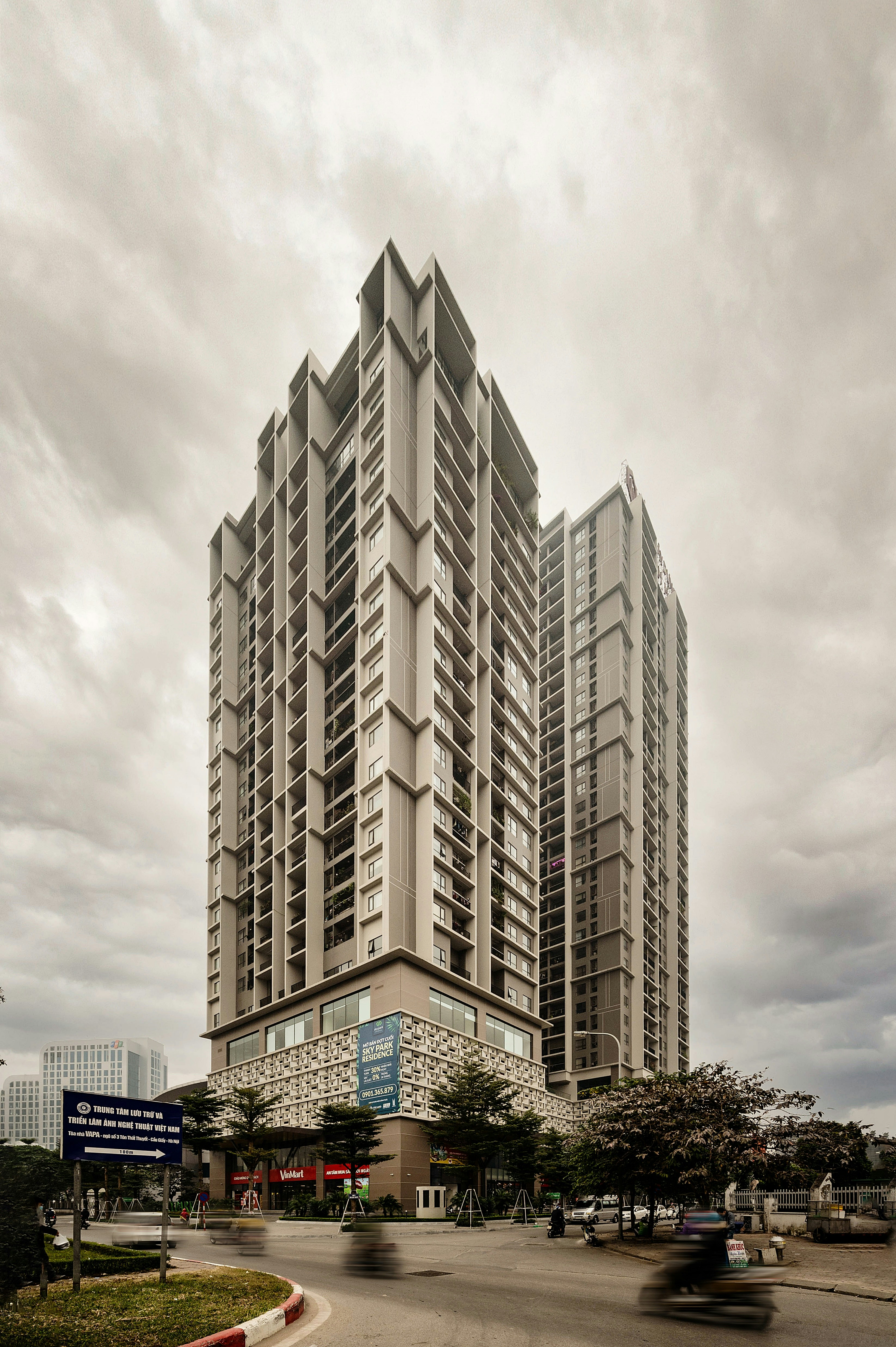 Monolithic Twins: A Modern High-Rise Pierces the Overcast