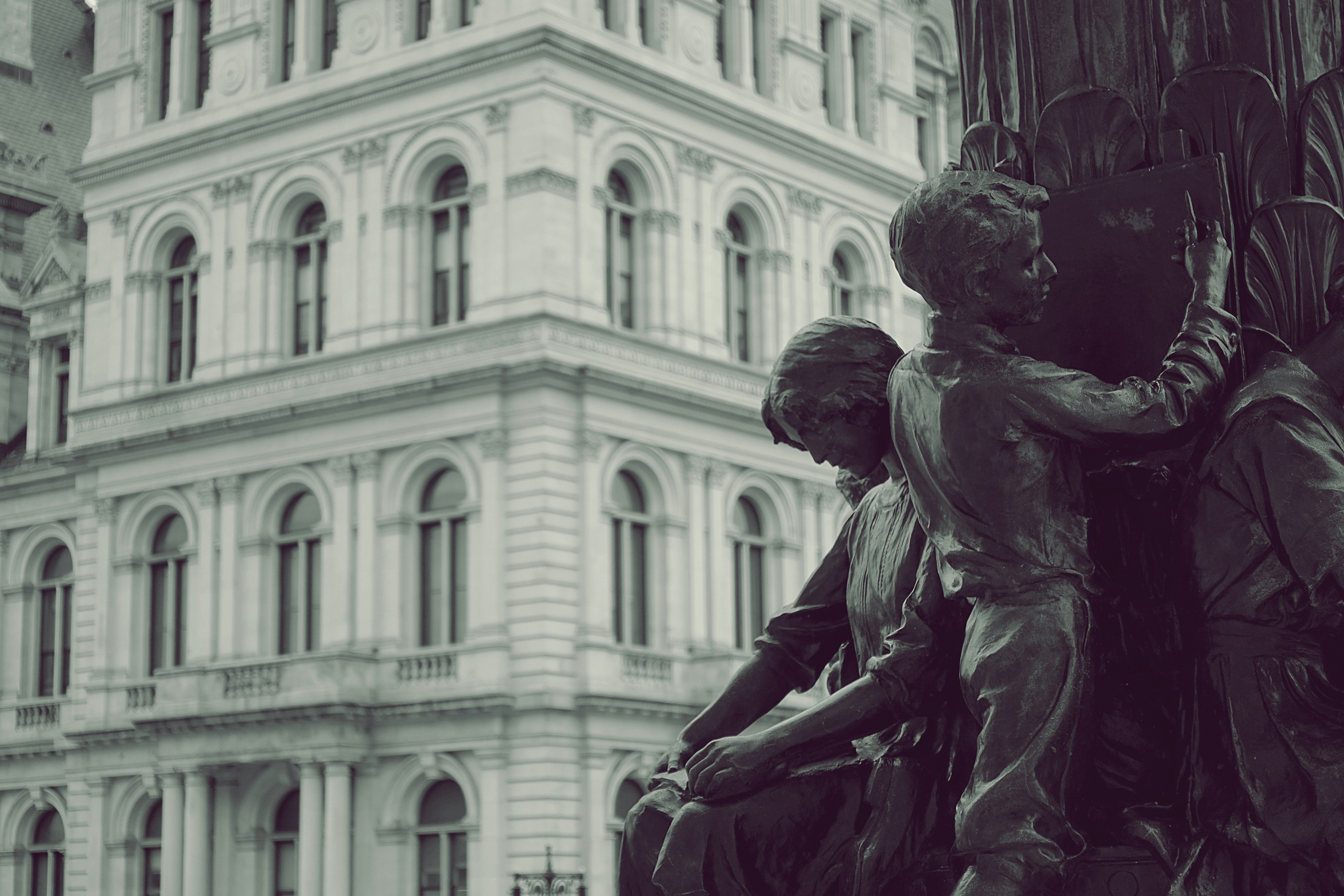 Stone Youths Bound to a City Facade