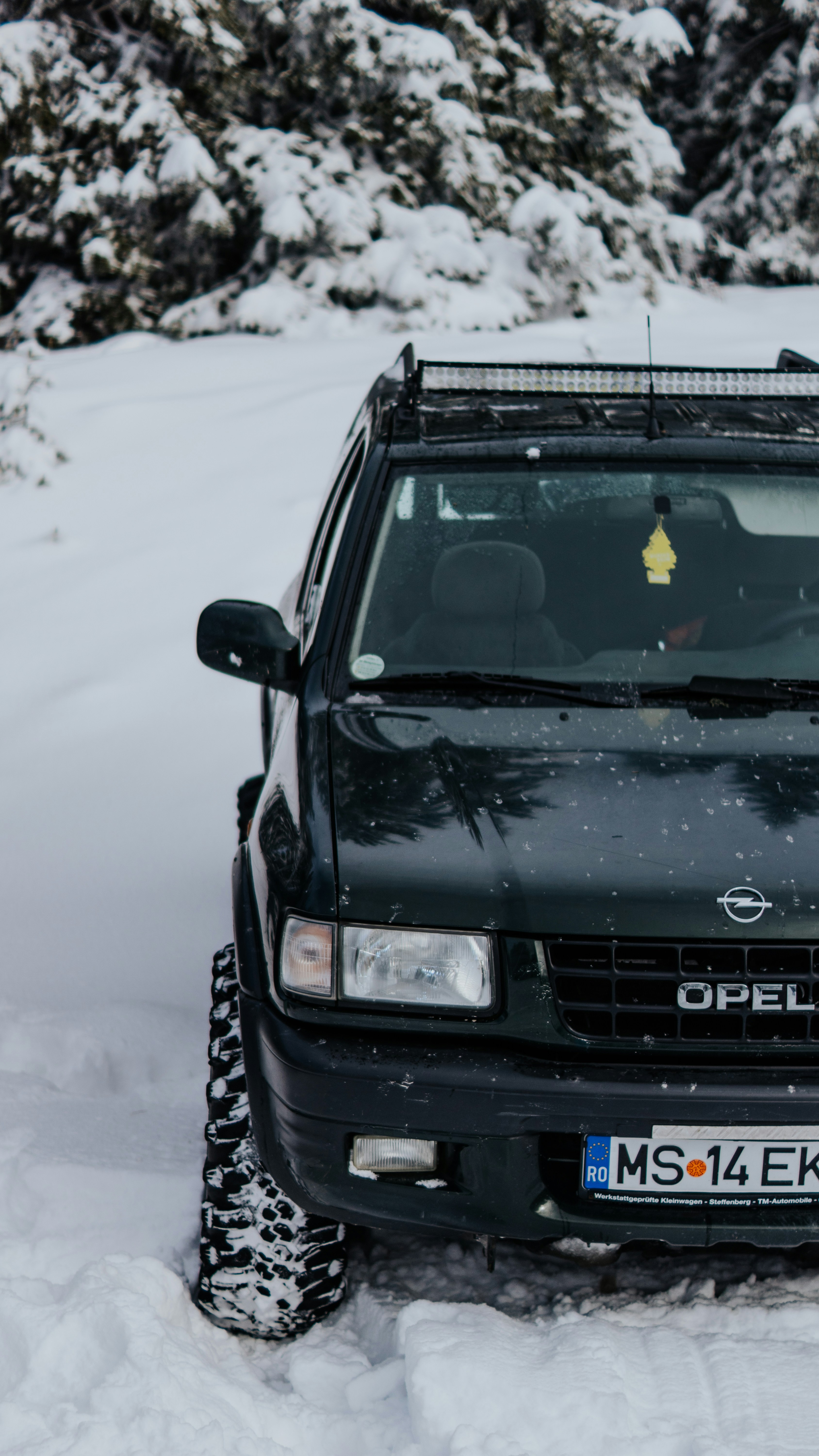 Snowbound Opel: A Rugged Ride Anchored by Winter White